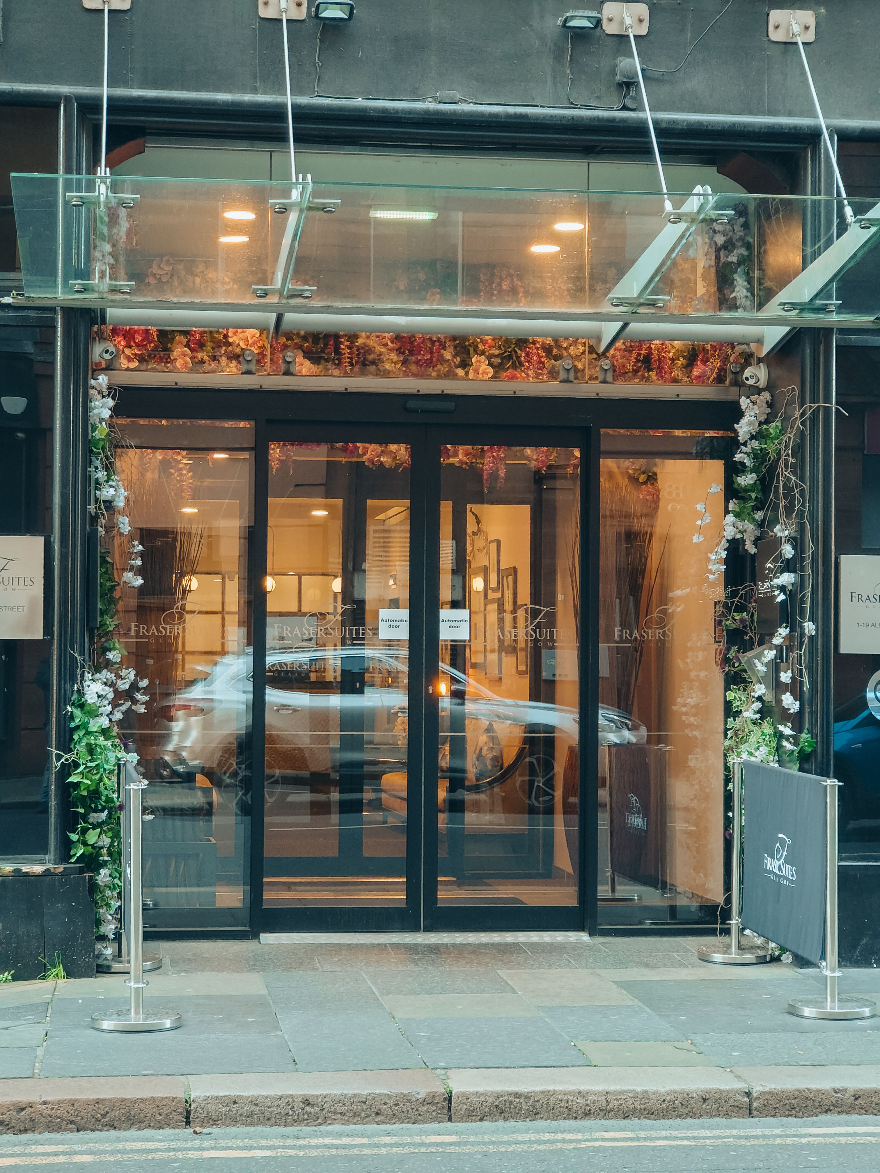 The entrance to a hotel with a sign that says, welcome to the hotel ...