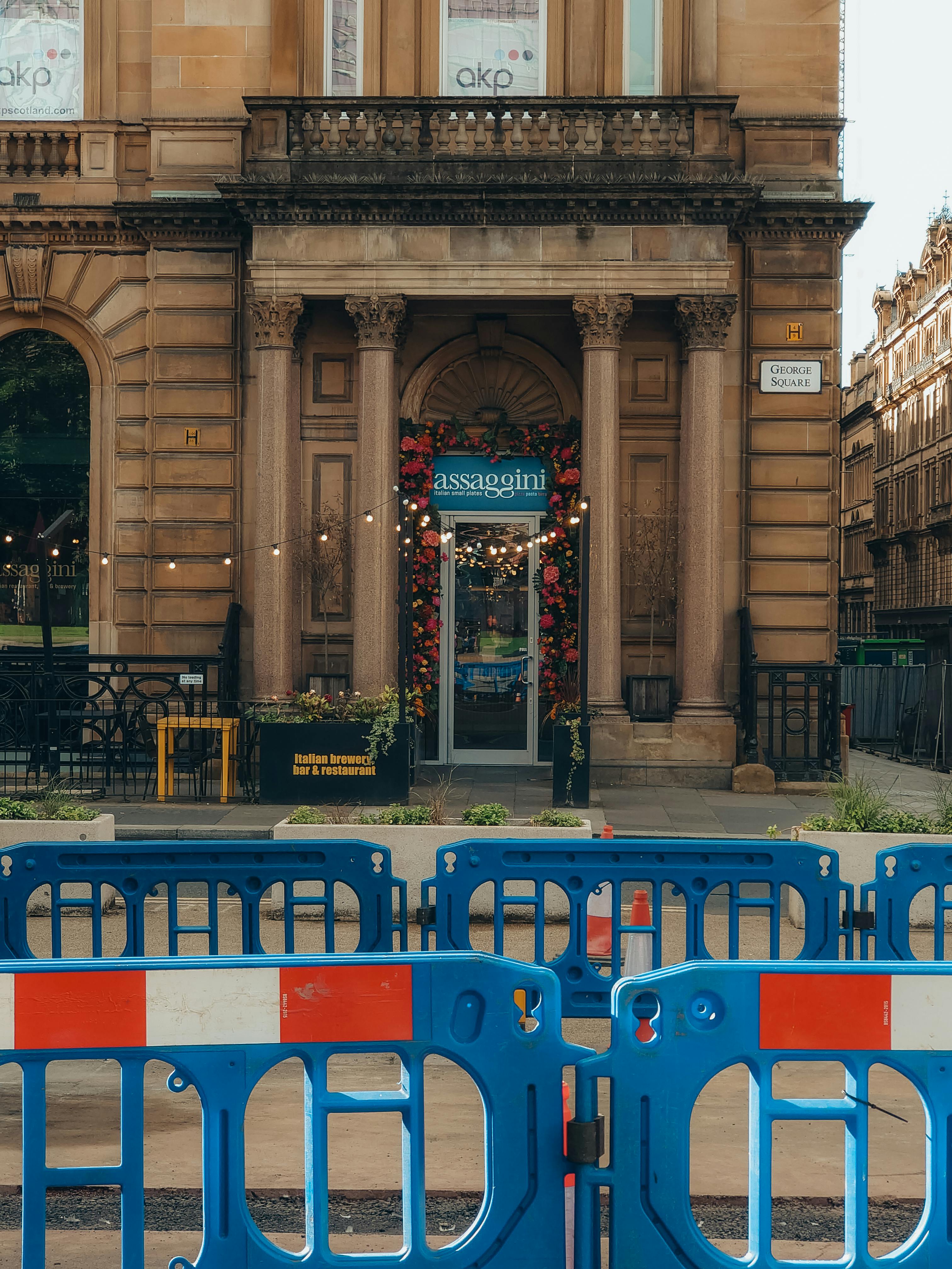 A blue and white barricade in front of a building · Free Stock Photo