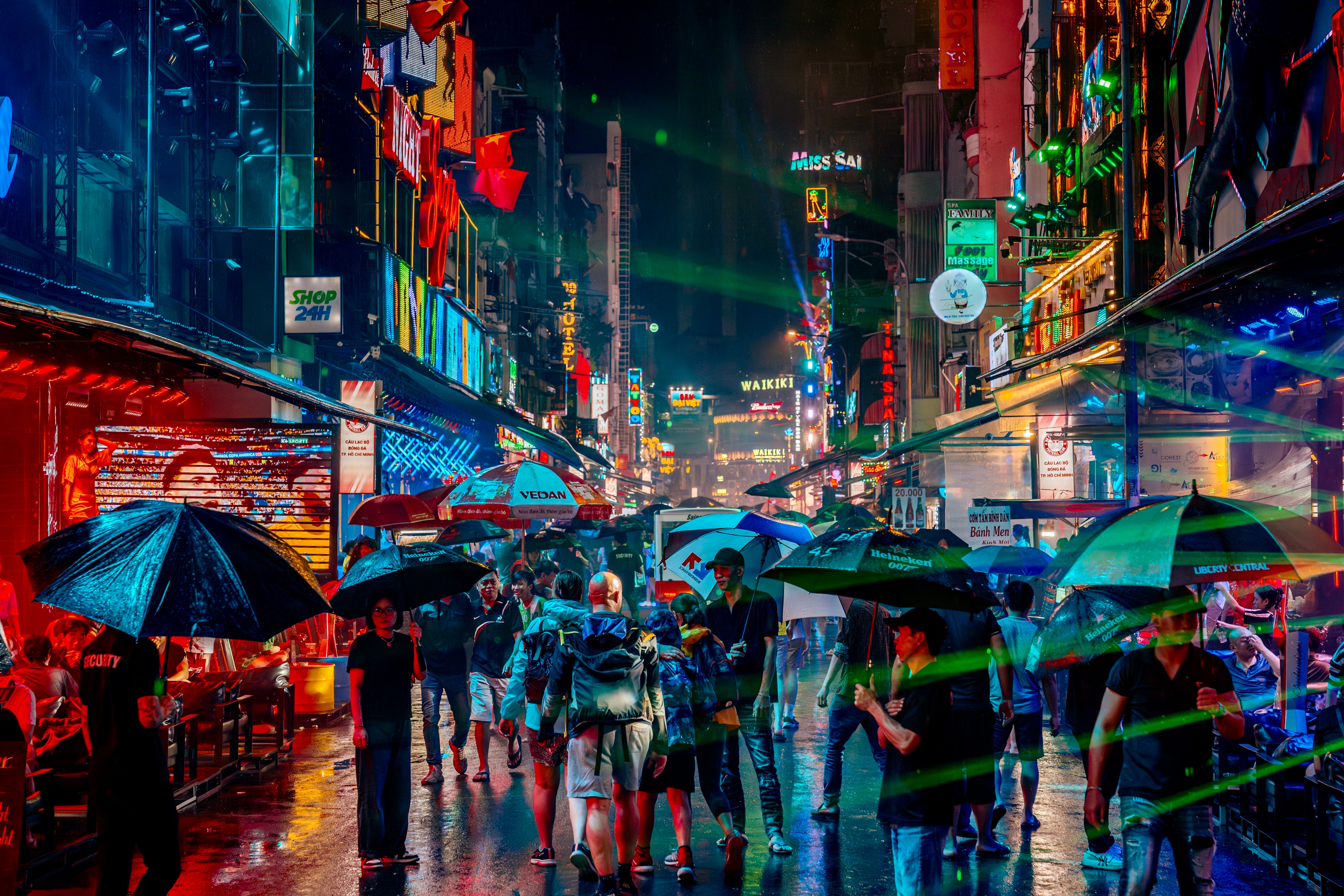 Vibrant Nightlife on a Rainy City Street · Free Stock Photo