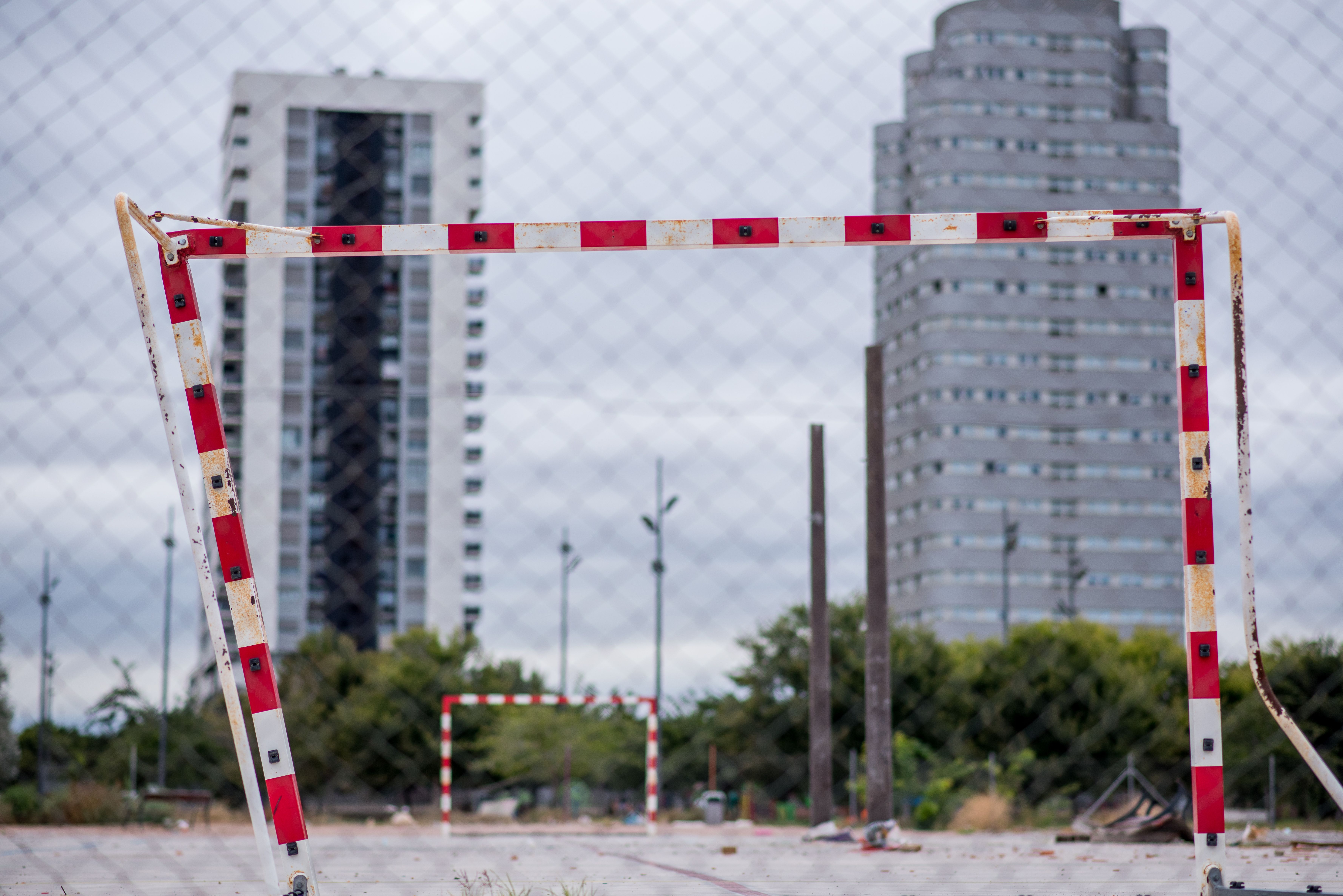 A red and white fence with a gate in front of a building · Free Stock Photo