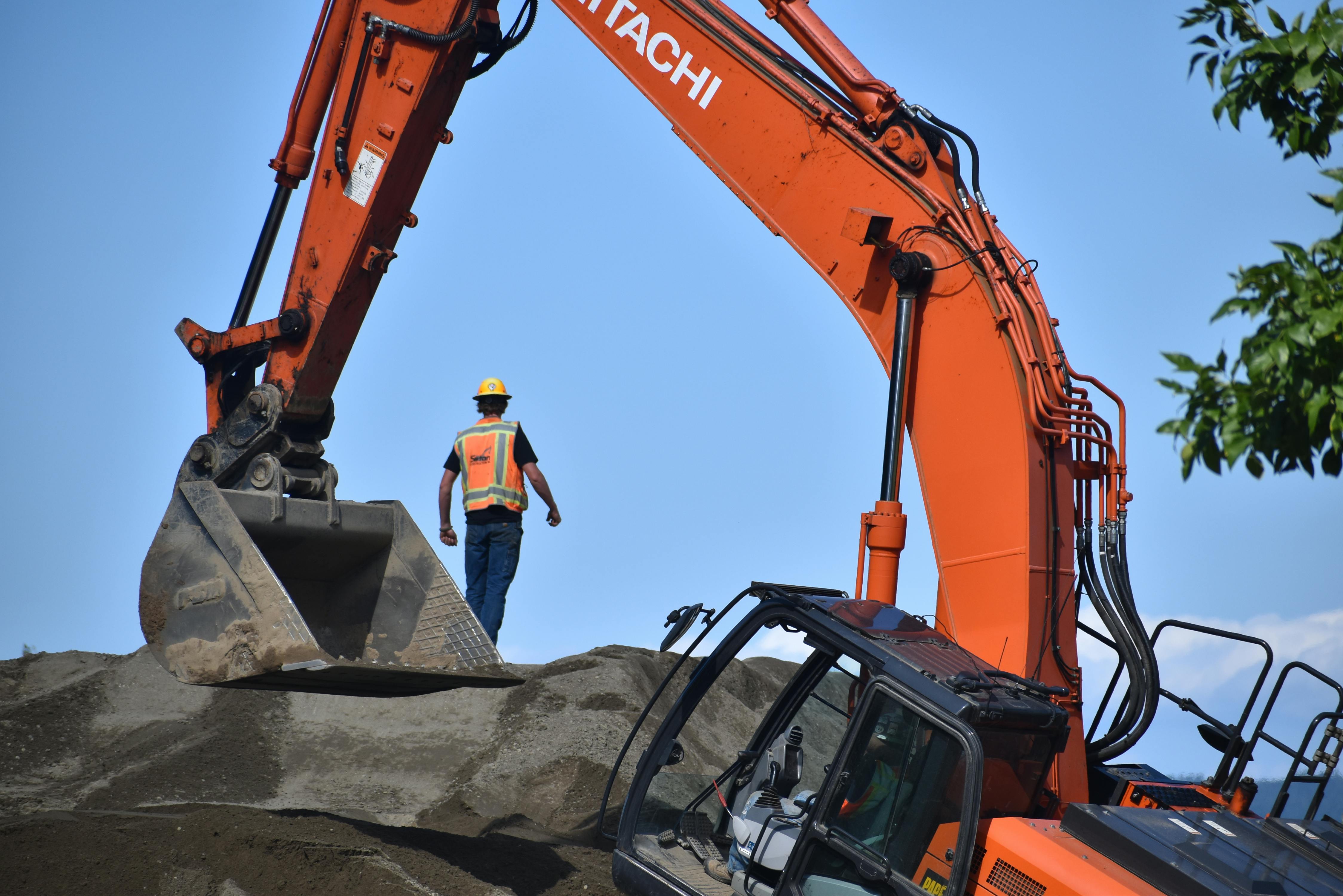 Construction Worker Operating Excavator Outdoors · Free Stock Photo