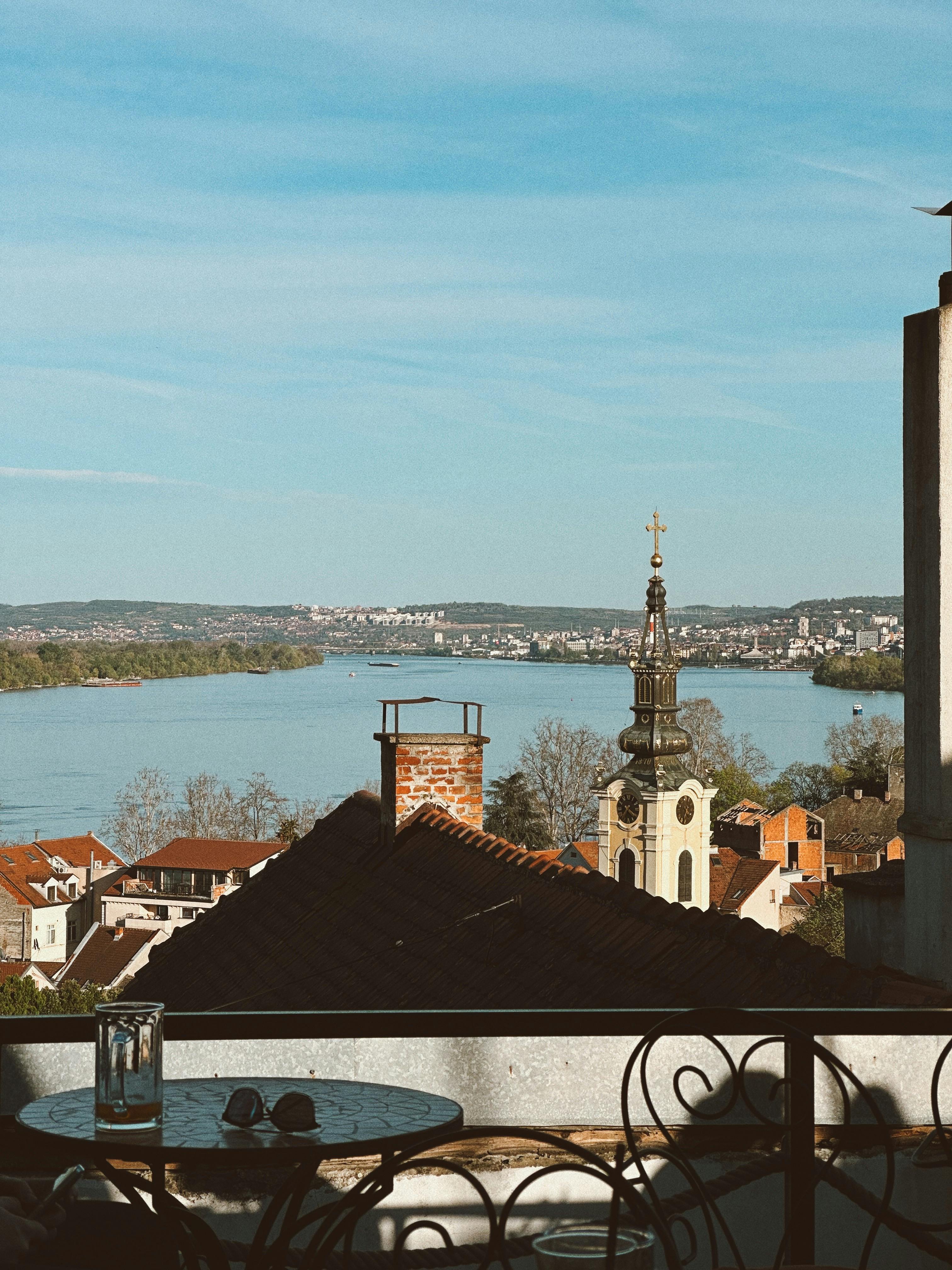 Danube River view from a terrace with a church tower on a bright day ...