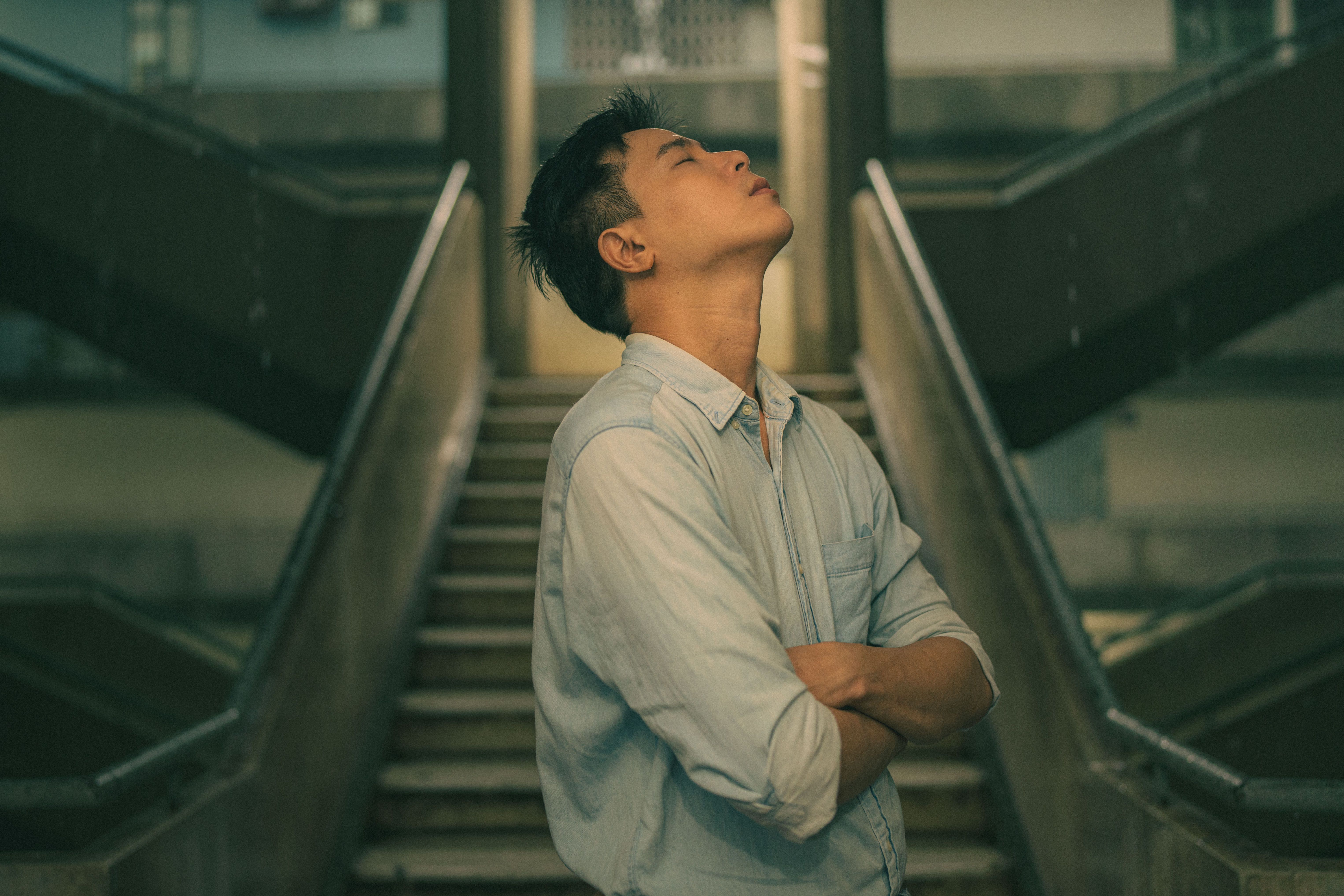 A man standing on the stairs looking up · Free Stock Photo