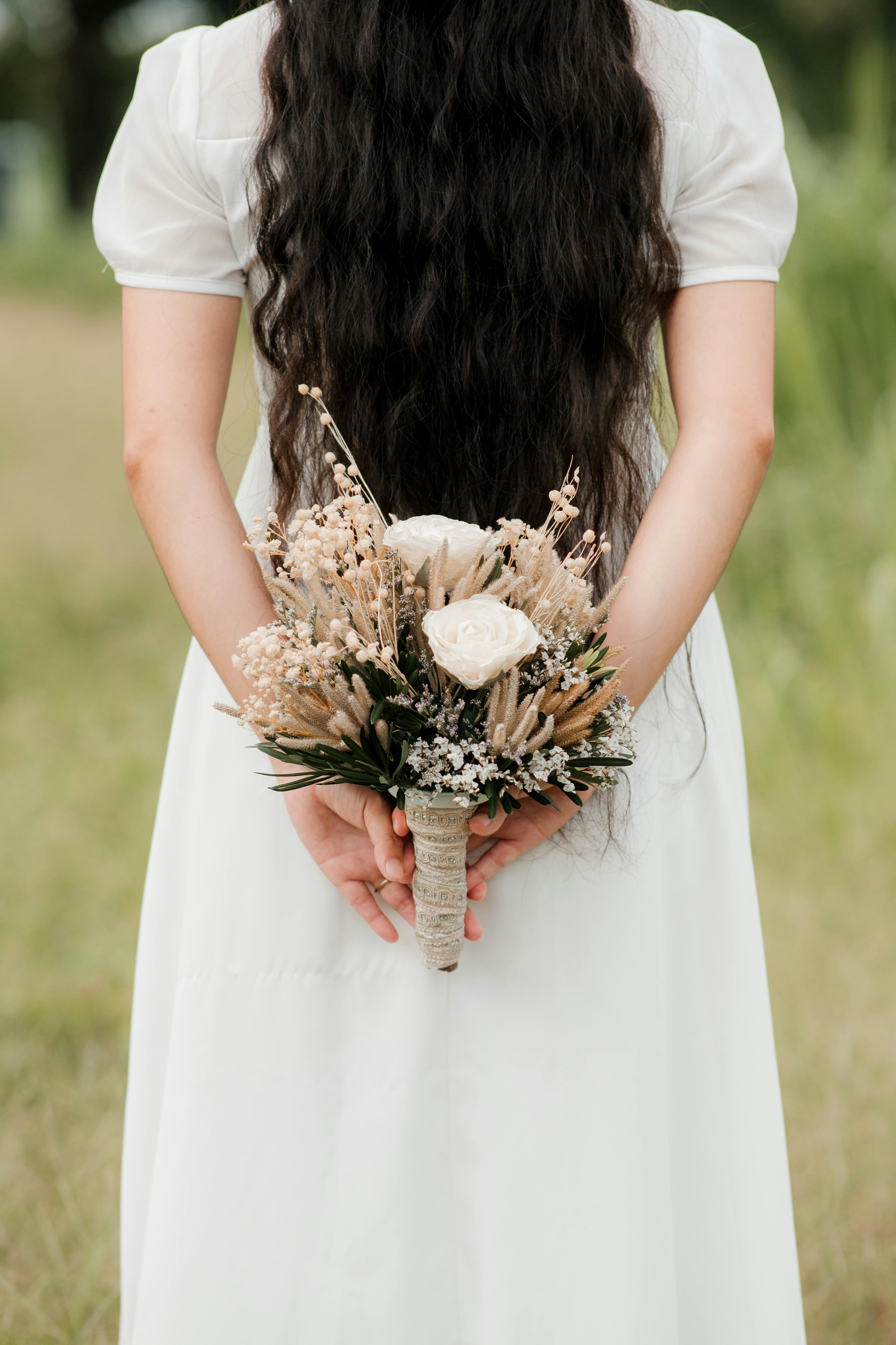 Bride Holding Bouquet in Outdoor Engagement Scene · Free Stock Photo