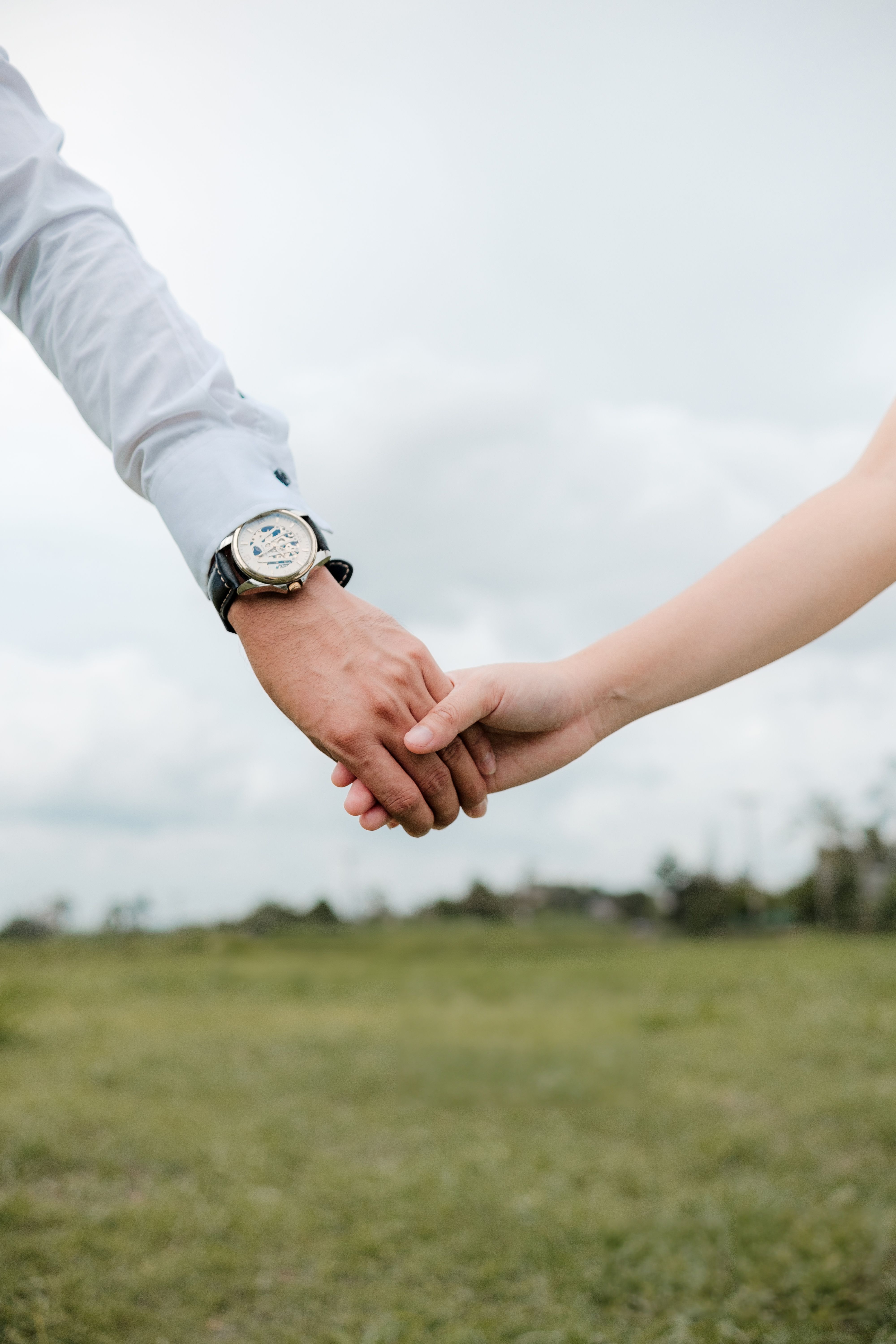 Romantic Couple Holding Hands Outdoors · Free Stock Photo