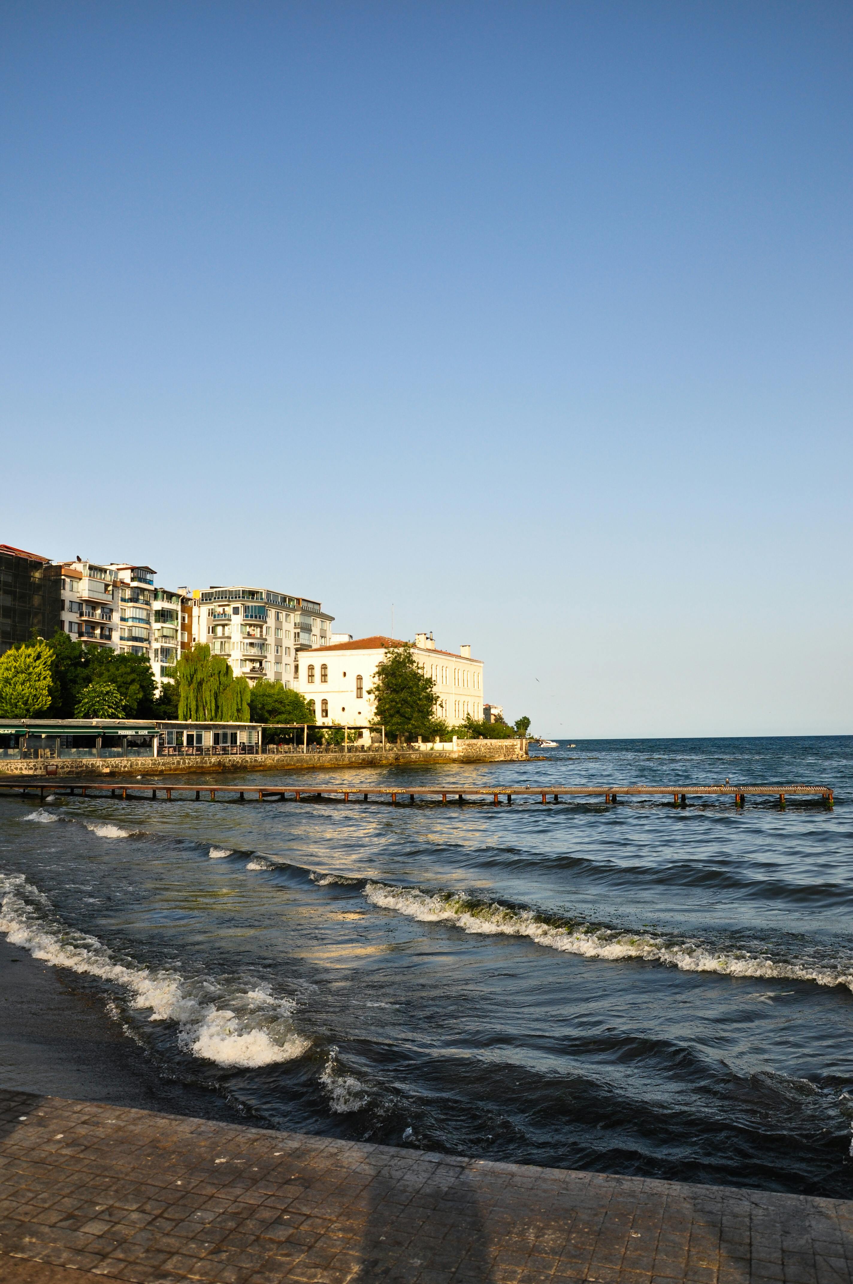 Scenic Coastal View of Urban Waterfront Architecture · Free Stock Photo