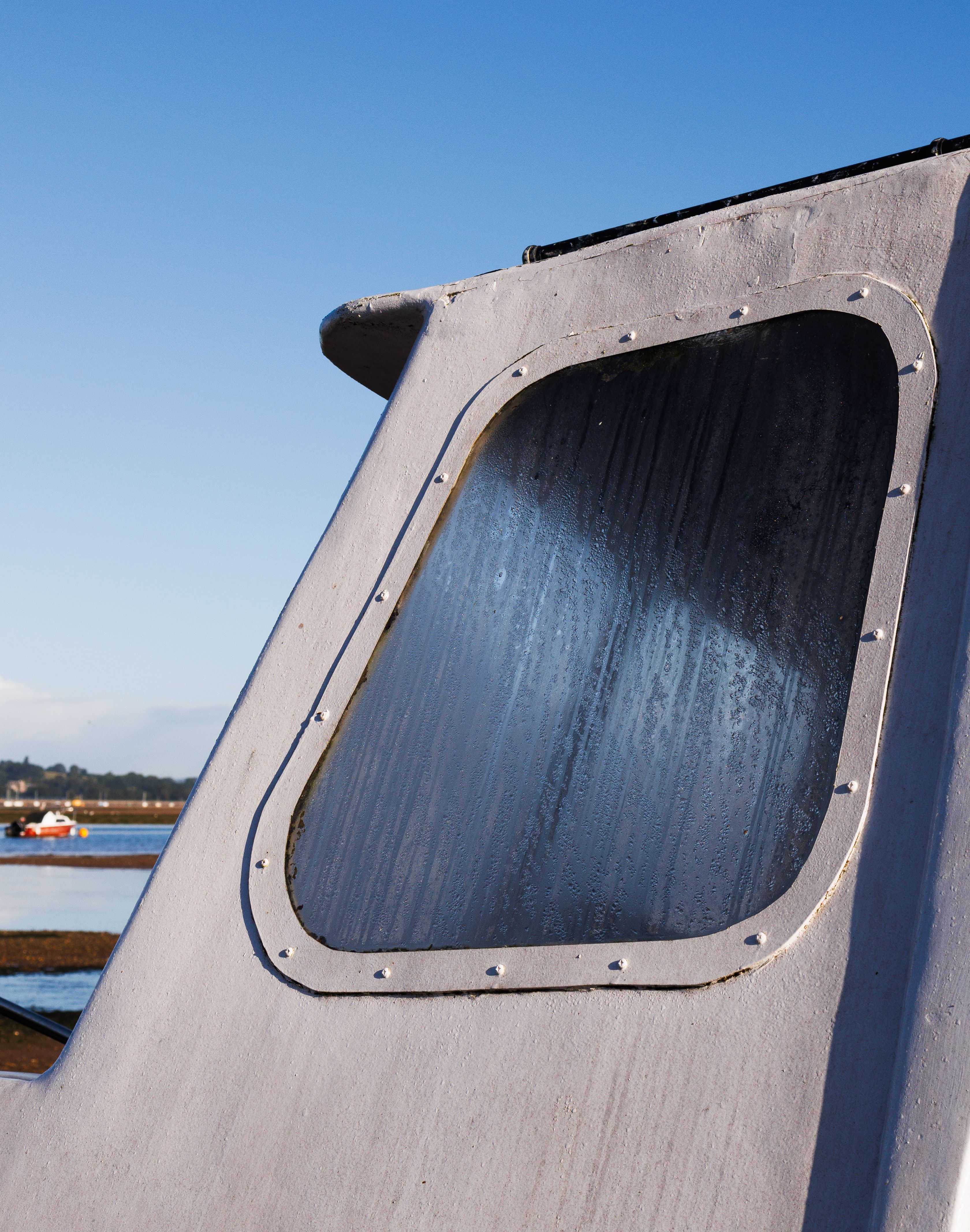 Close-up of Boat Window with Riverside View · Free Stock Photo