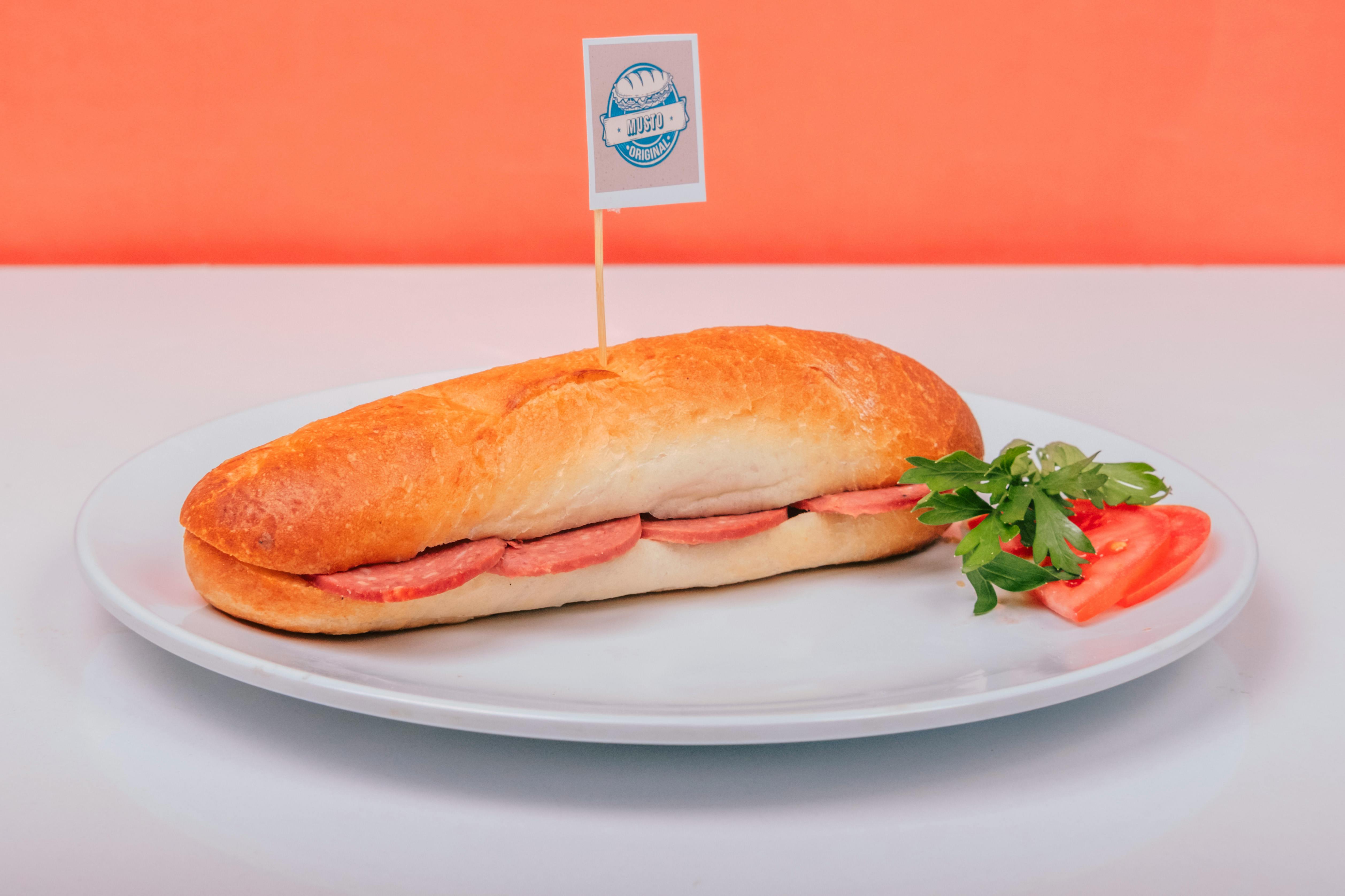 Delicious Sub Sandwich with Fresh Garnish on Plate · Free Stock Photo