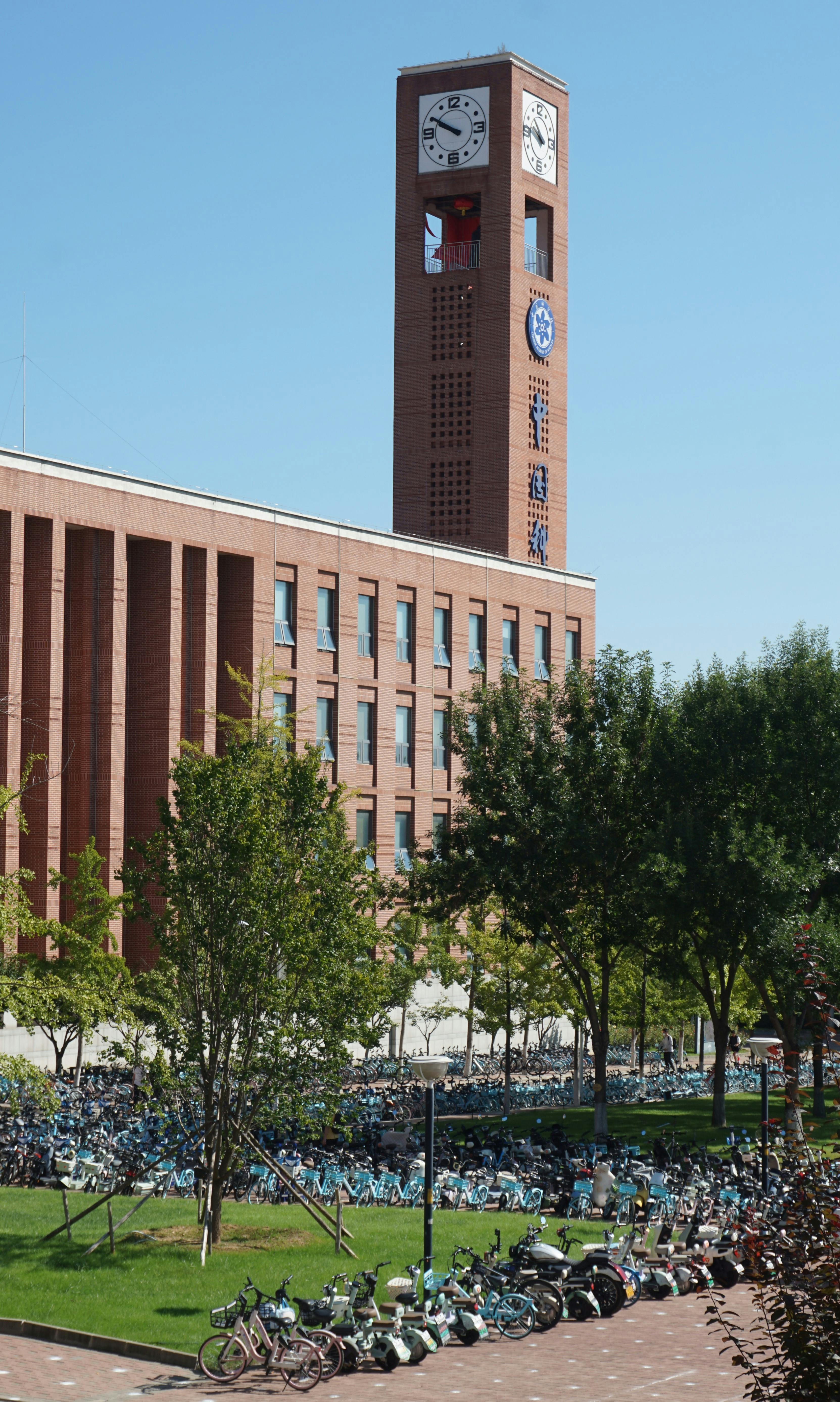 Clock Tower and Bikes at Campus on Sunny Day · Free Stock Photo
