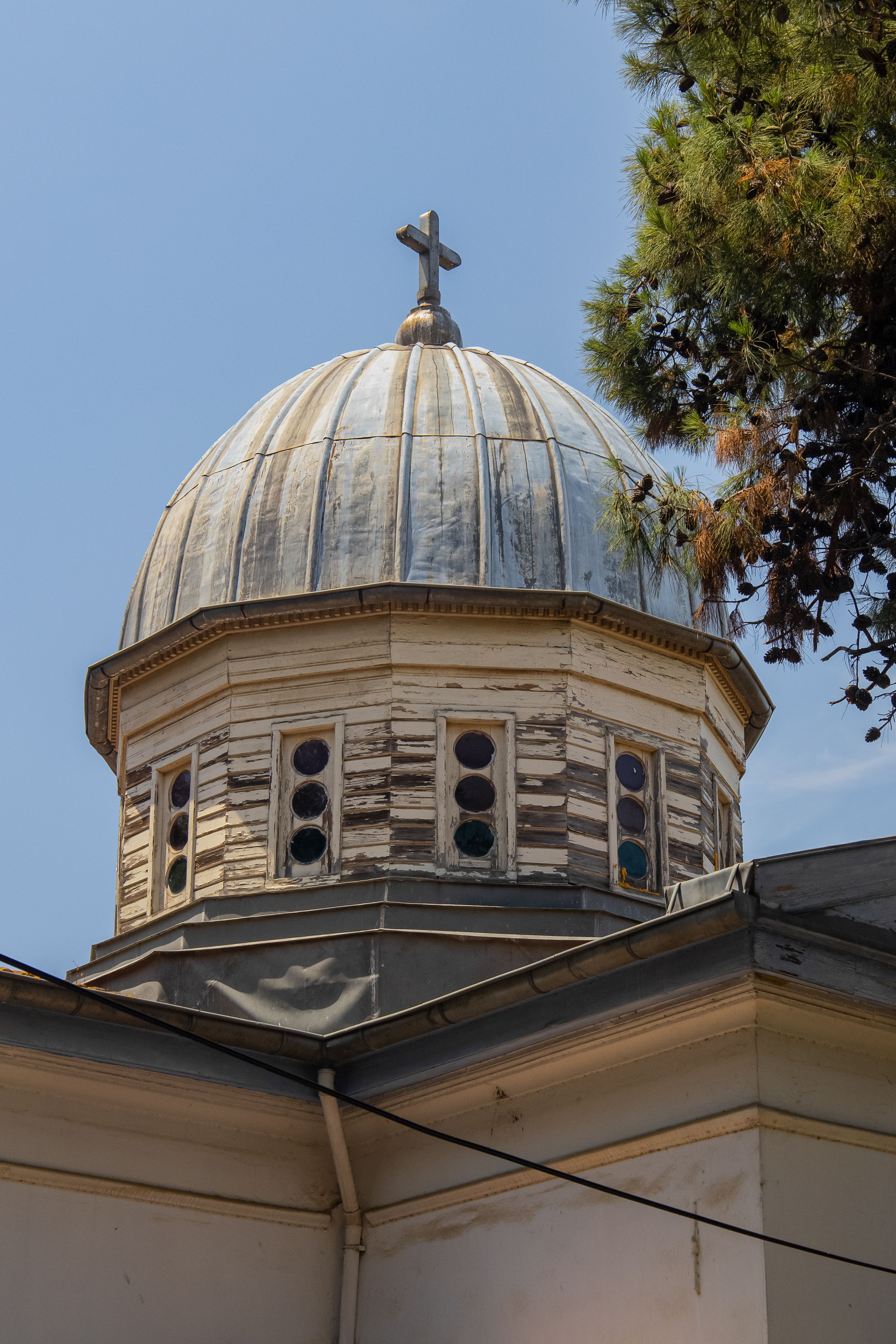 Historic Church Dome with Cross Against Blue Sky · Free Stock Photo