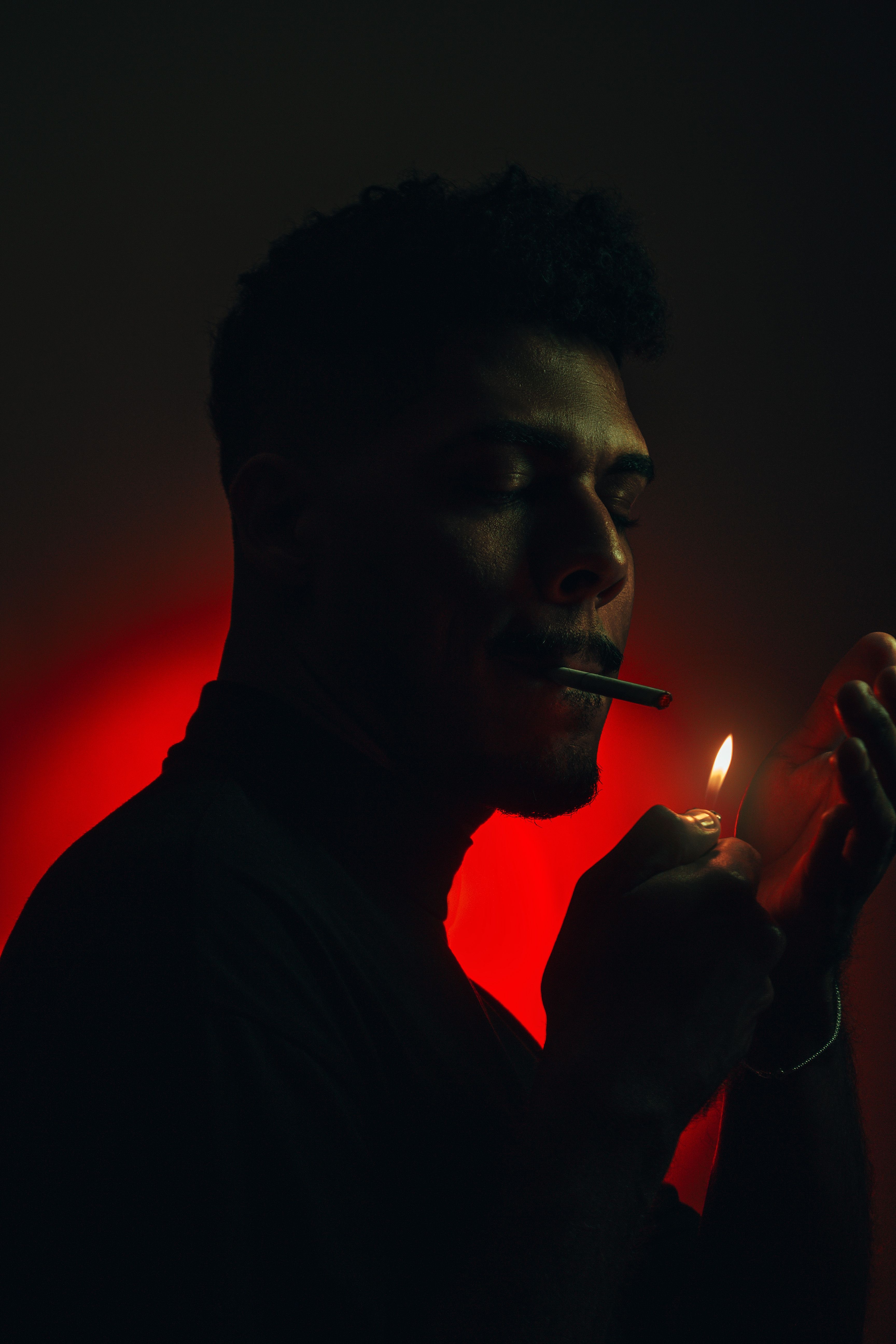 Moody Portrait of Smoking Man with Red Backlight · Free Stock Photo