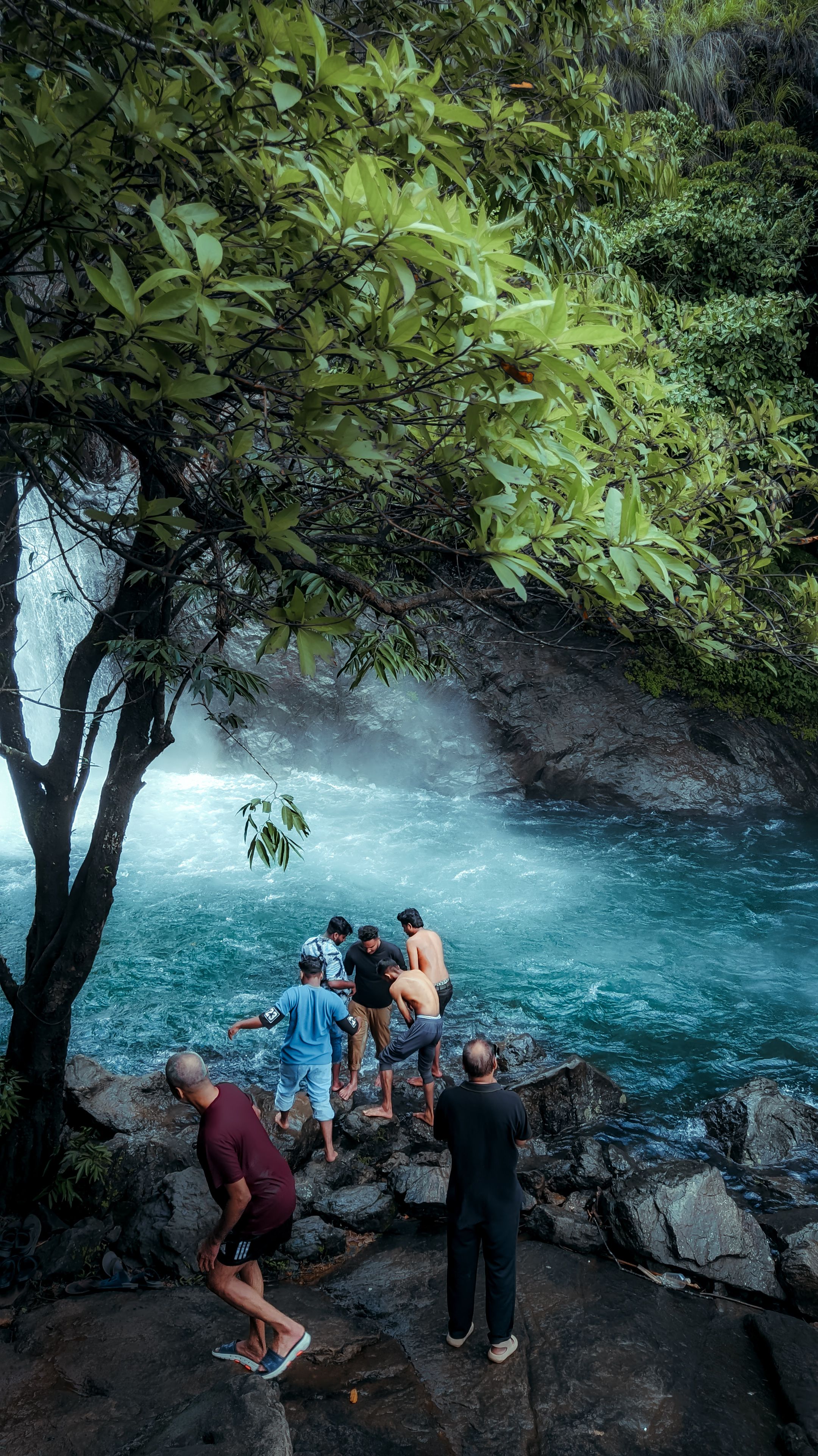 Group Exploring Scenic Waterfall in Nature · Free Stock Photo