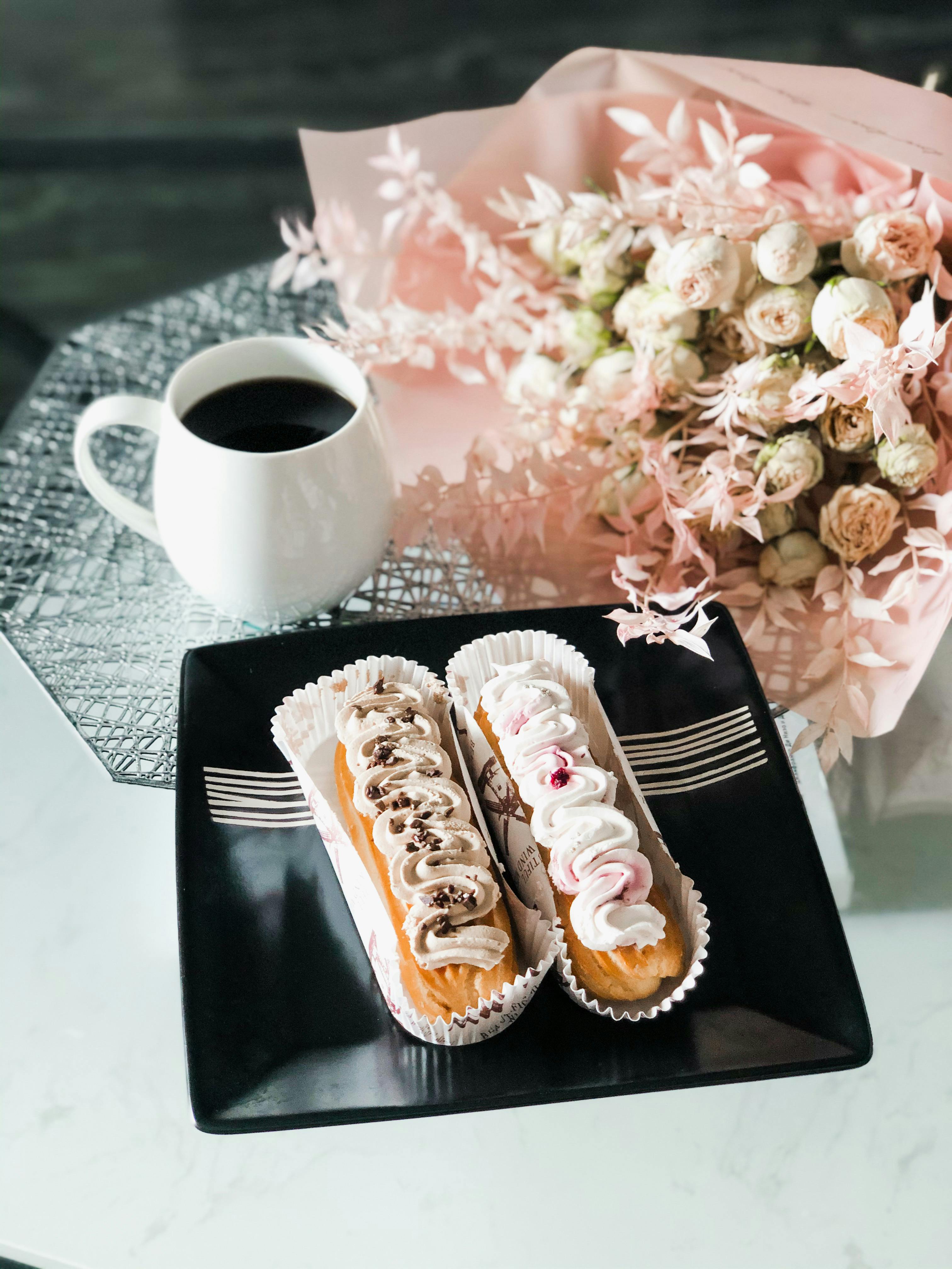 Elegant Coffee Break with Eclairs and Flowers · Free Stock Photo