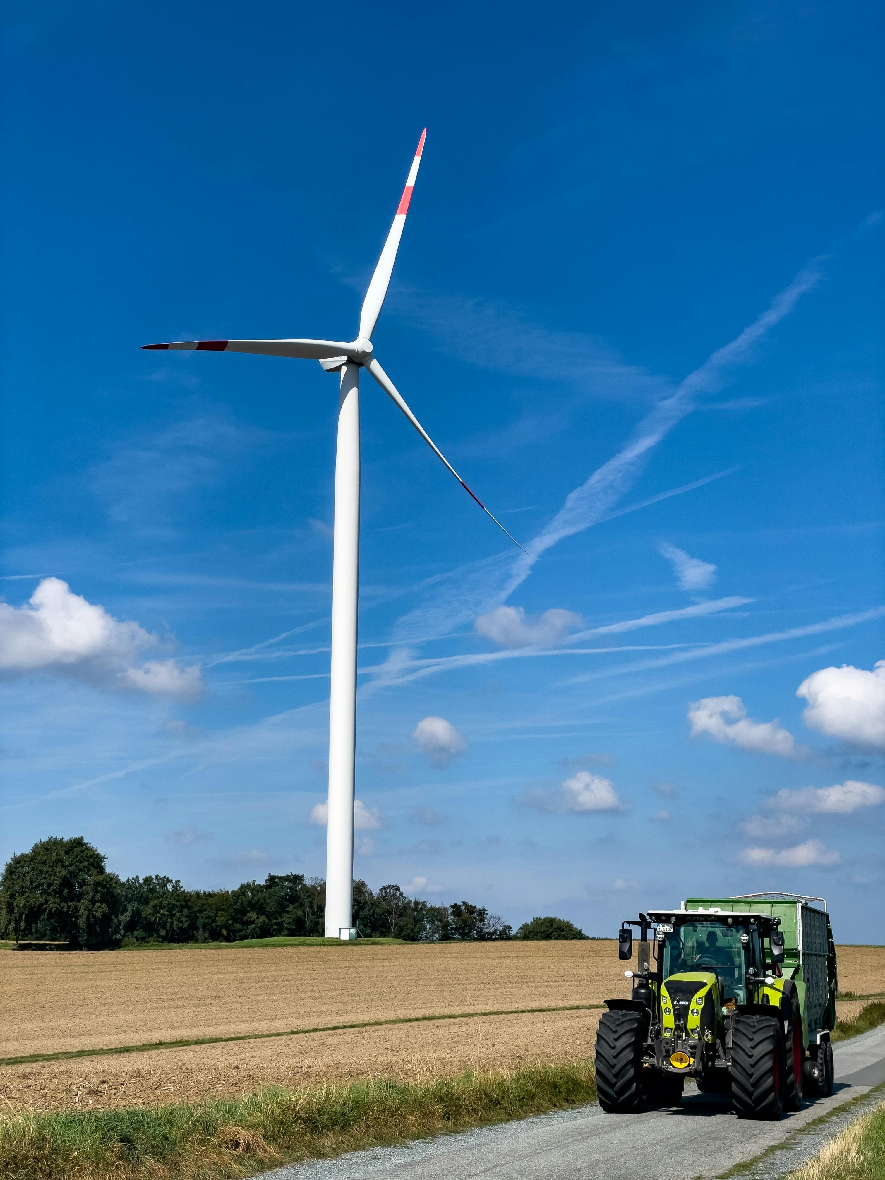 Wind Turbine and Tractor on Farmland in Summer · Free Stock Photo