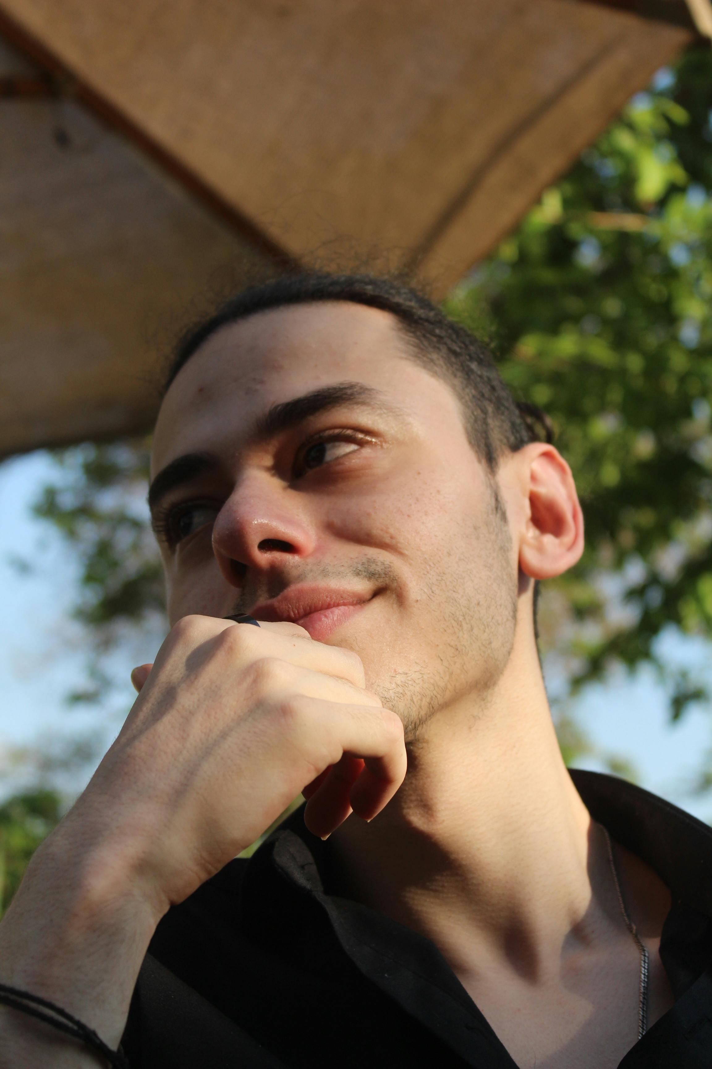 Reflective Young Man Outdoors Portrait · Free Stock Photo