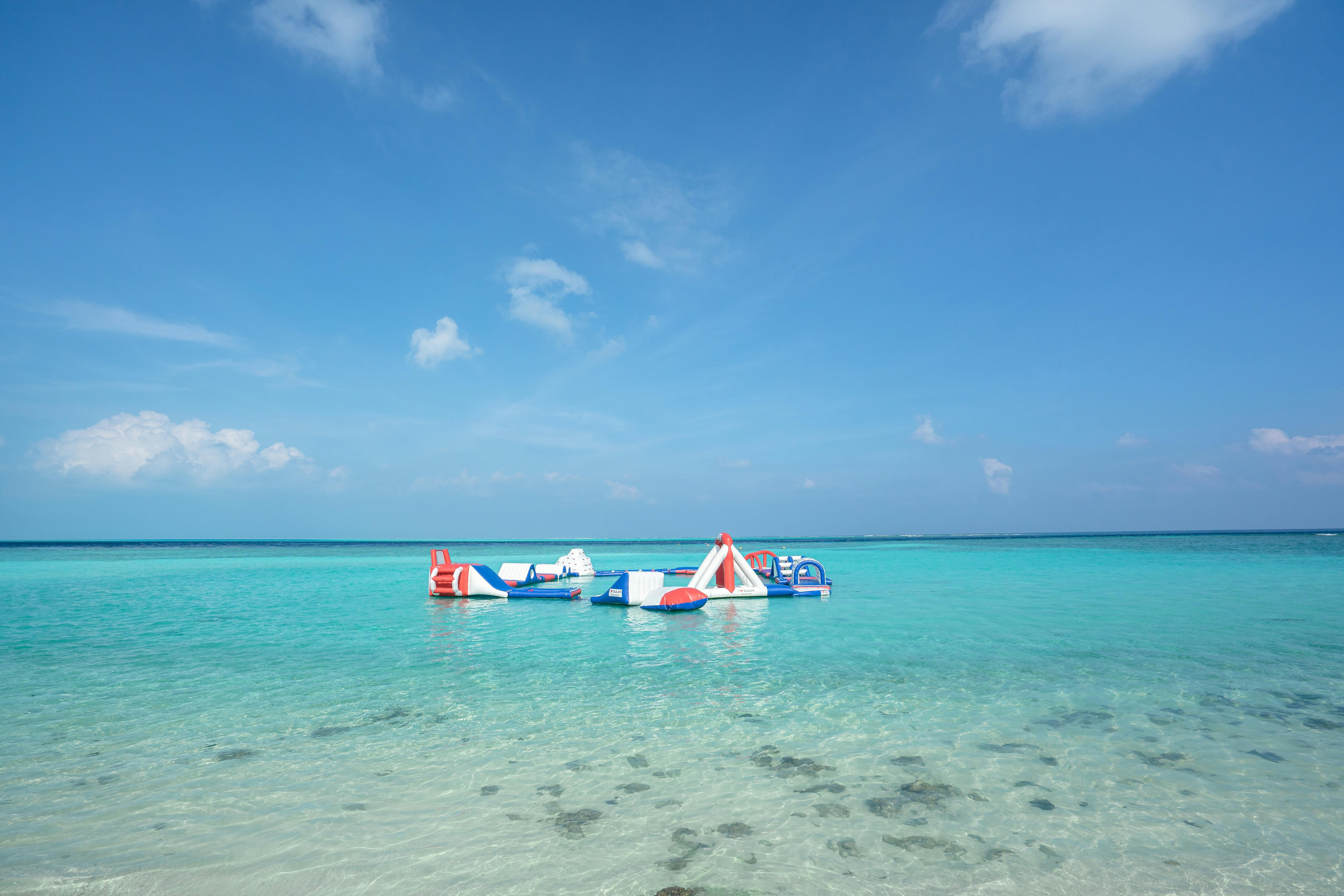 Colorful Inflatable Obstacle Course on Clear Beach · Free Stock Photo