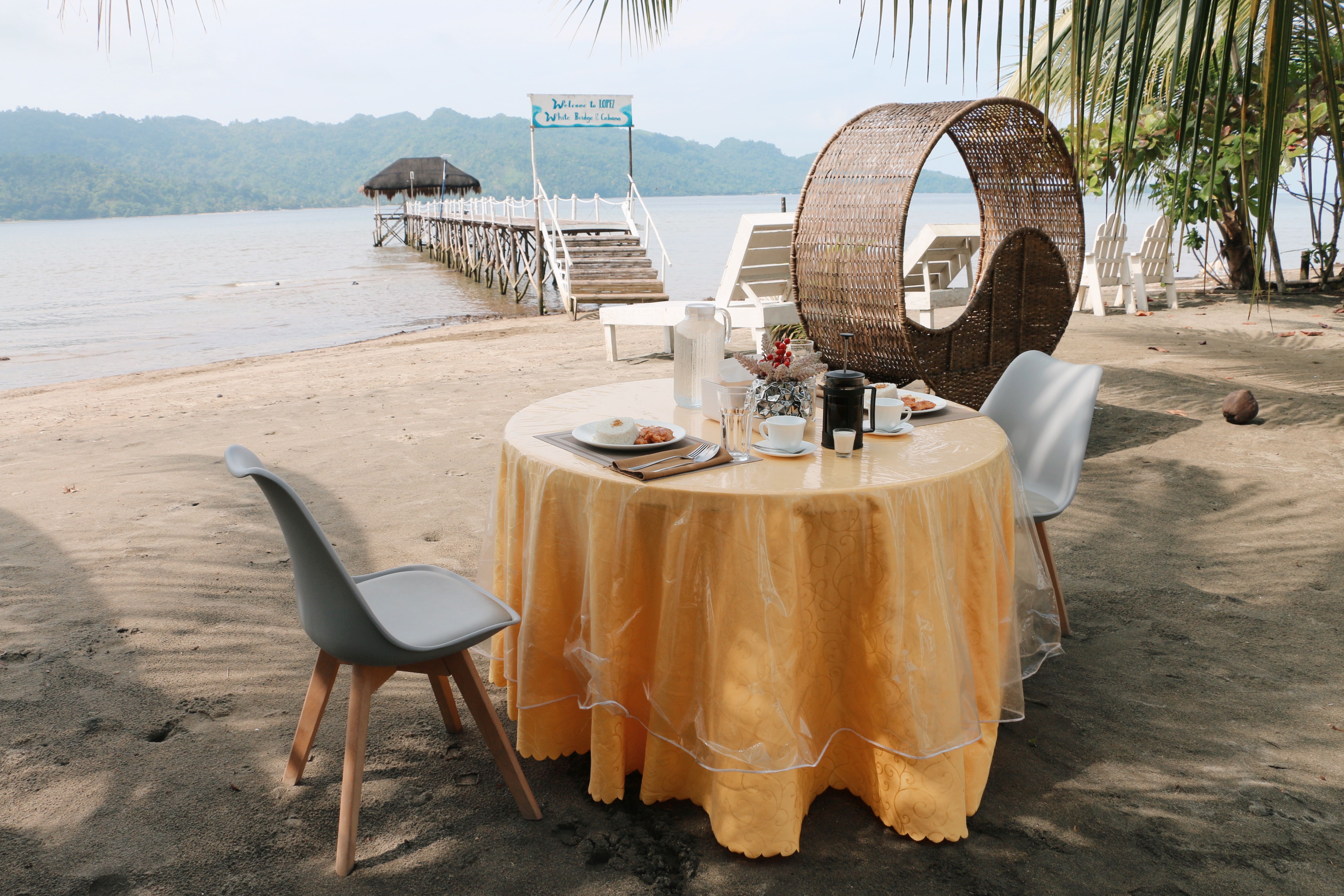 Beachfront Dining Setup with Scenic View · Free Stock Photo