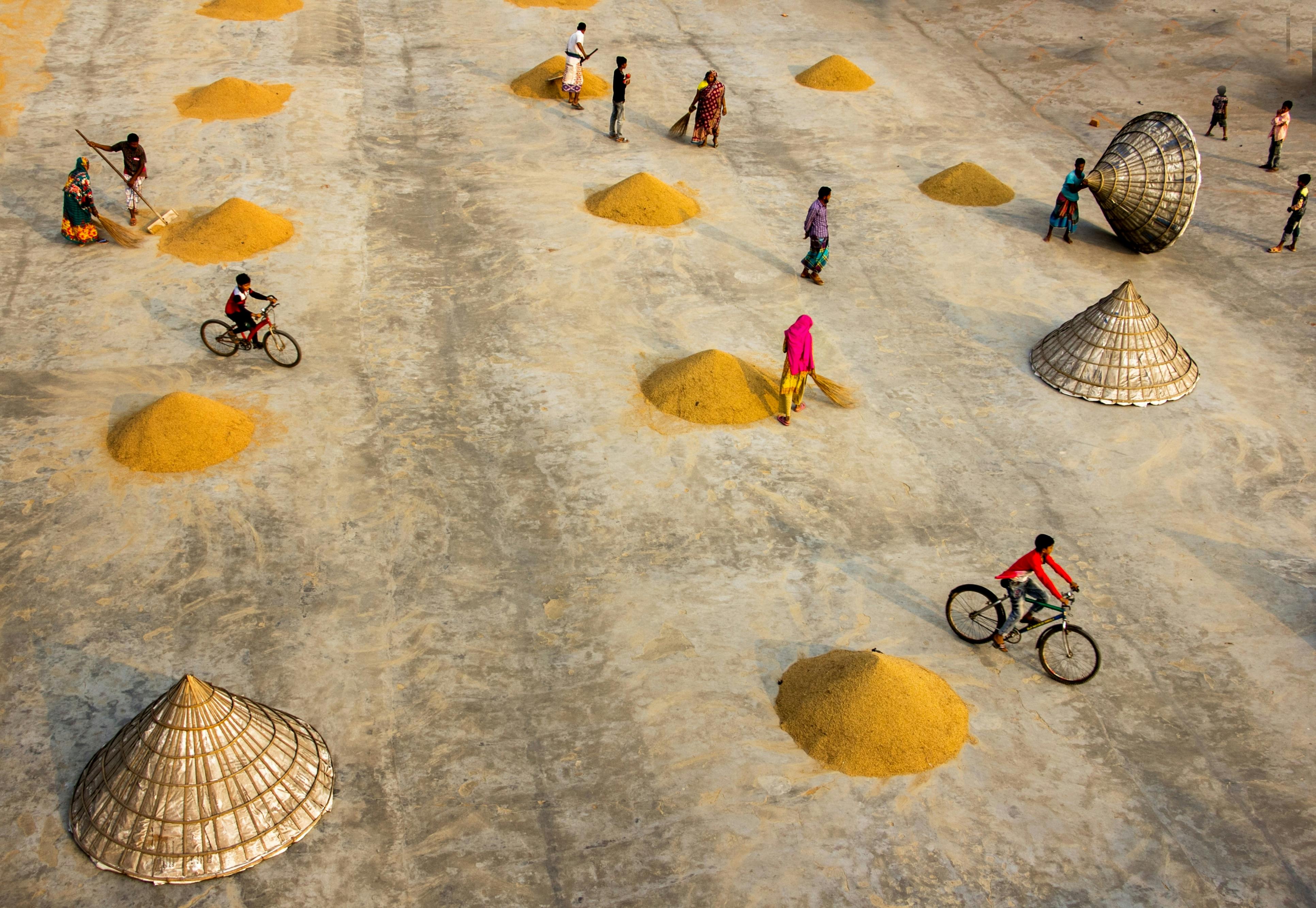 Aerial View of People Drying Grains Outdoors · Free Stock Photo