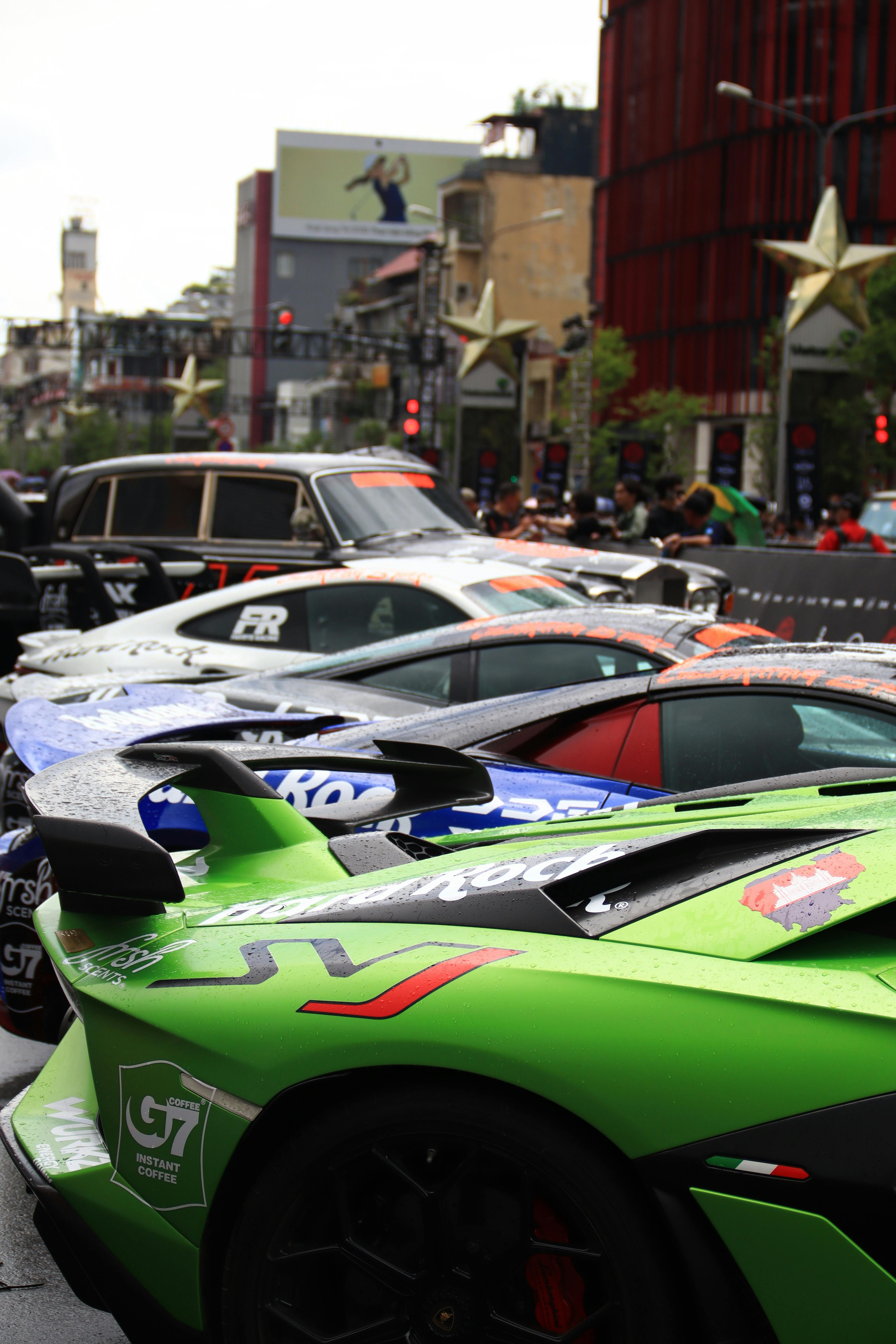 Luxurious Sports Cars in Urban Street Parade · Free Stock Photo