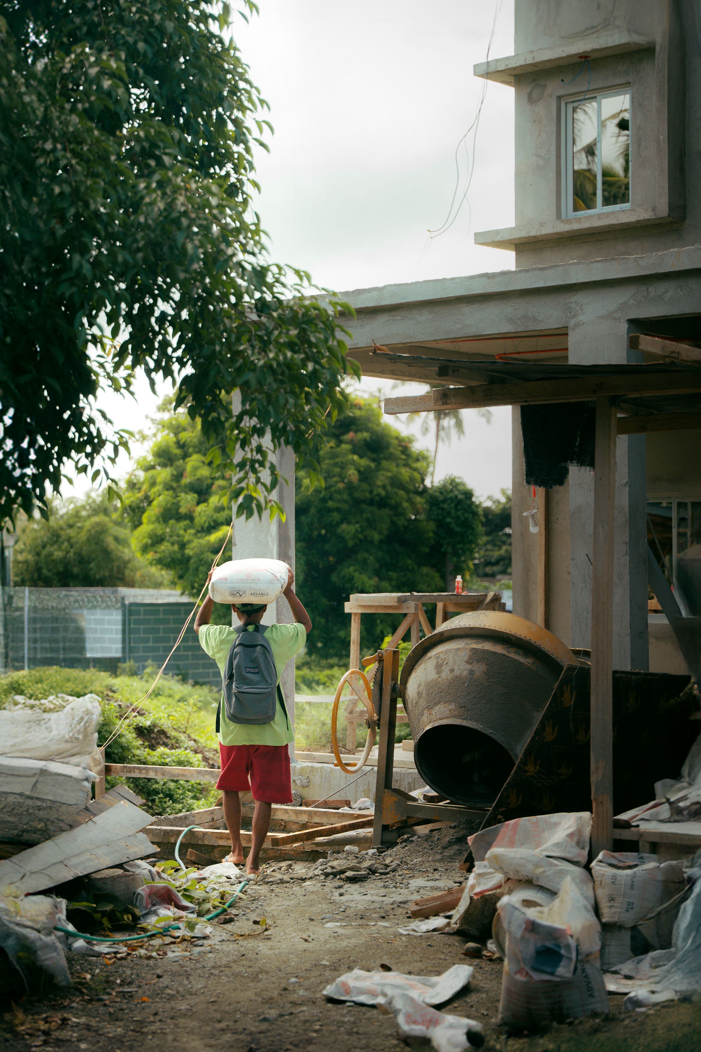 Construction Worker Carrying Cement at Building Site · Free Stock Photo