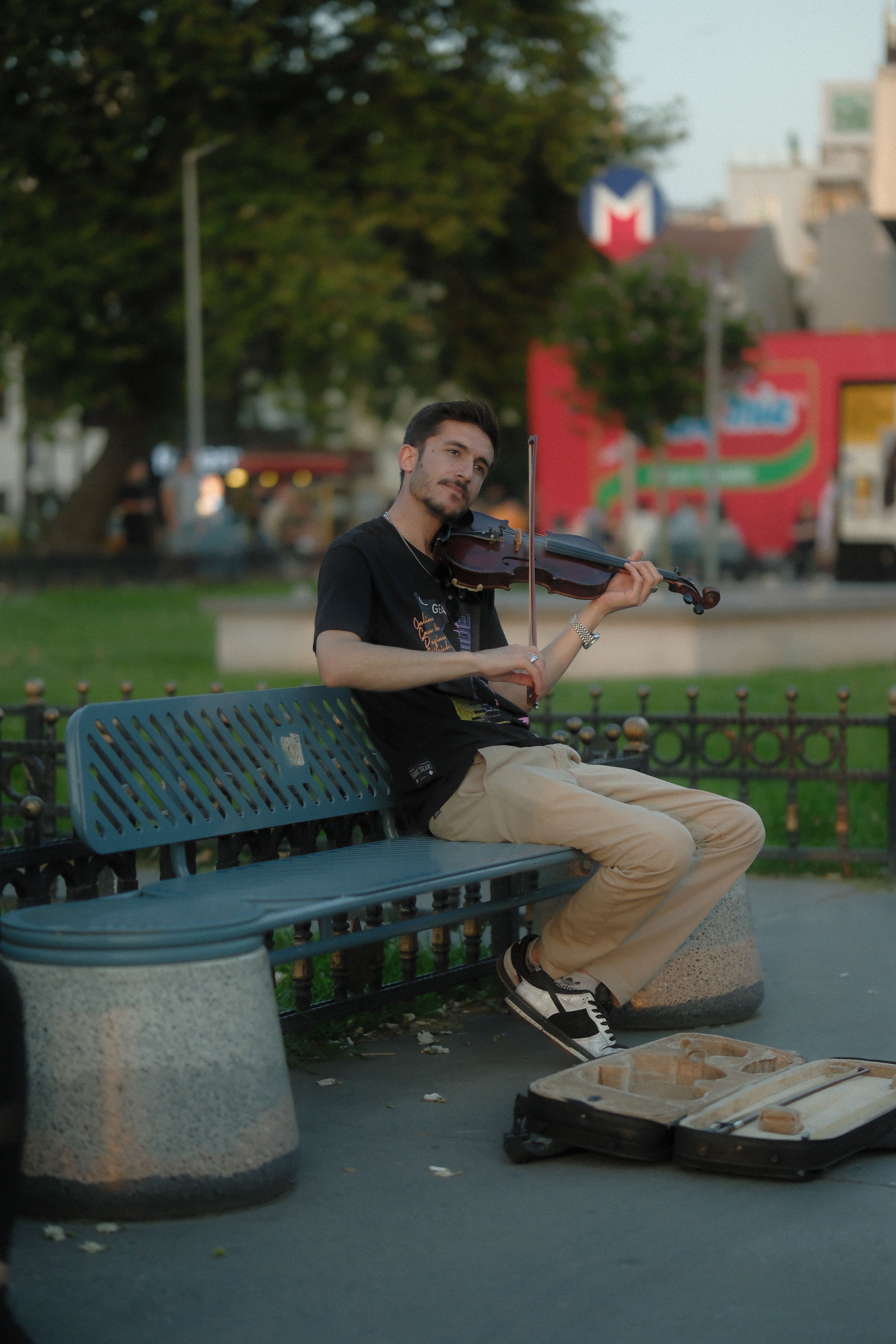 Street Musician Playing Violin on Park Bench · Free Stock Photo