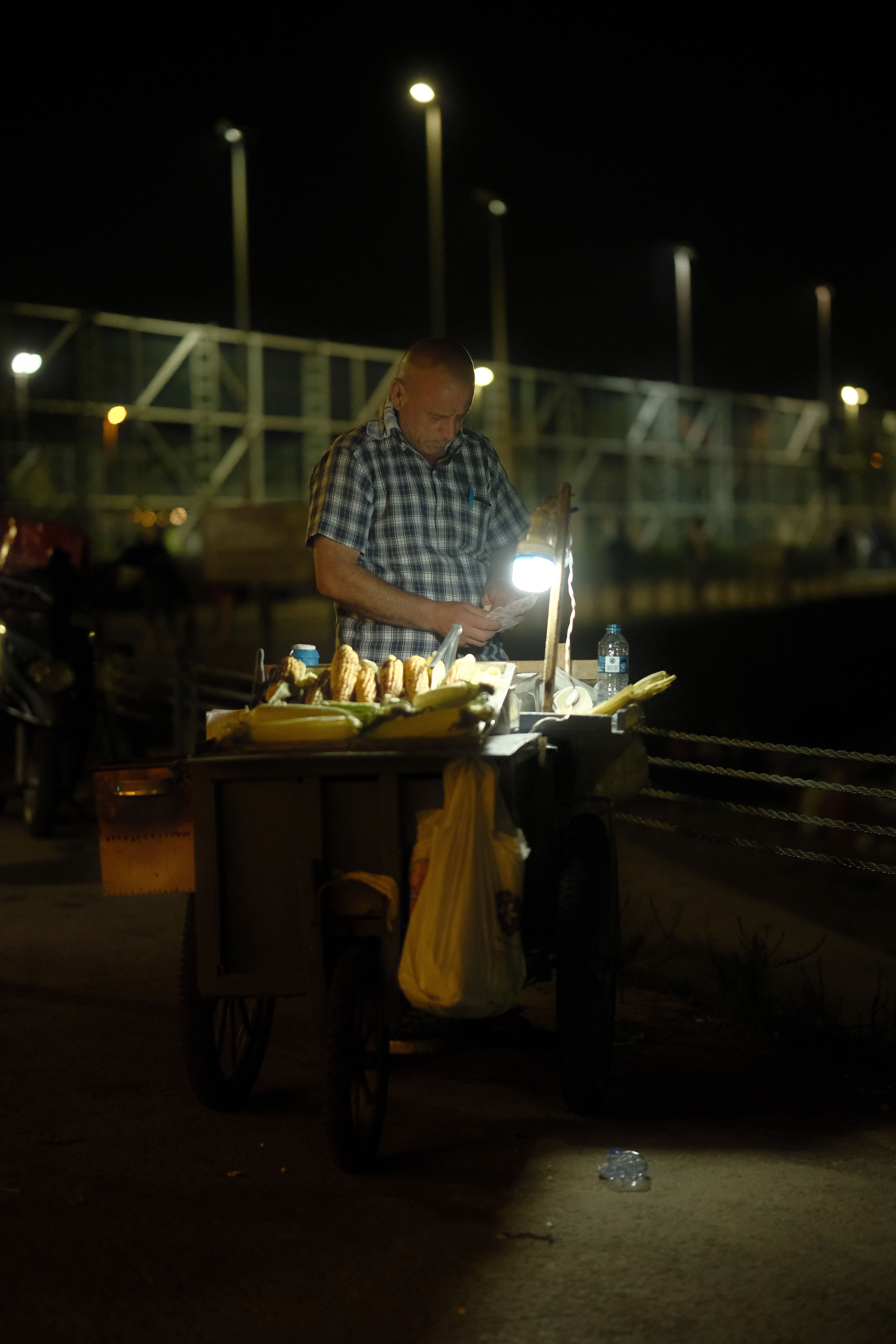 Night Street Vendor with Illuminated Cart · Free Stock Photo