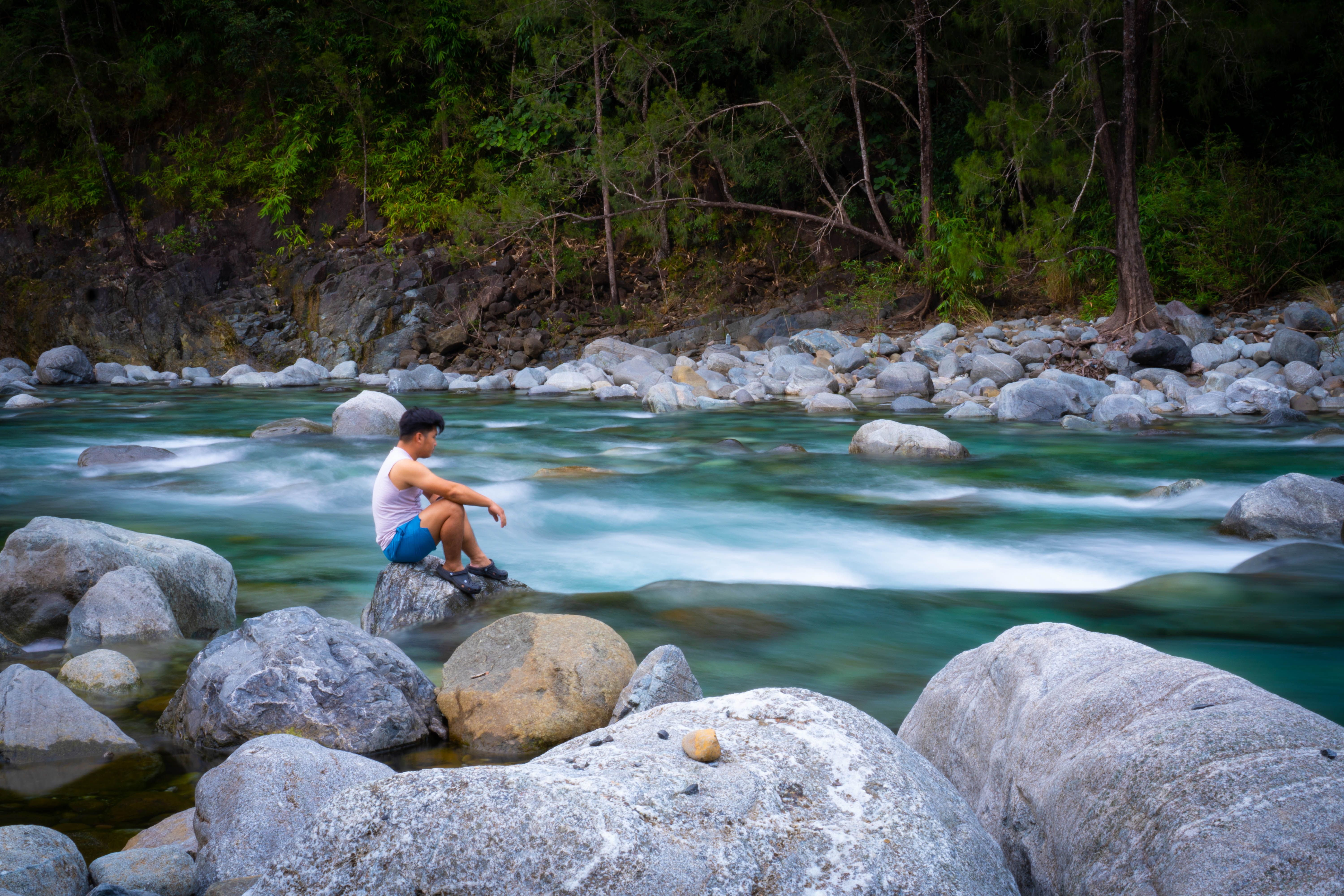 Tranquil Scene of a Person by Flowing River in Masinloc · Free Stock Photo
