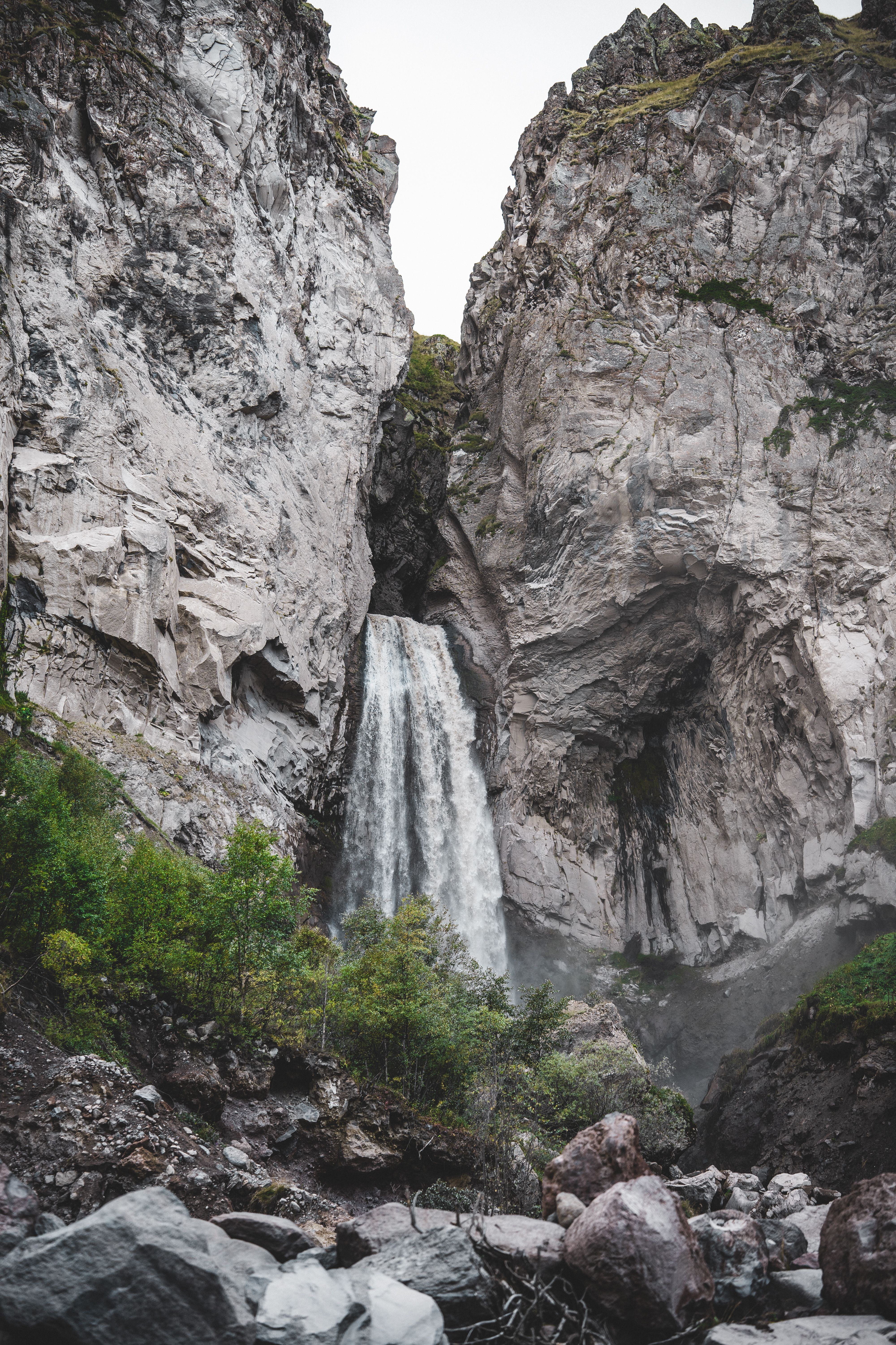 Man Sitting Near Waterfalls · Free Stock Photo
