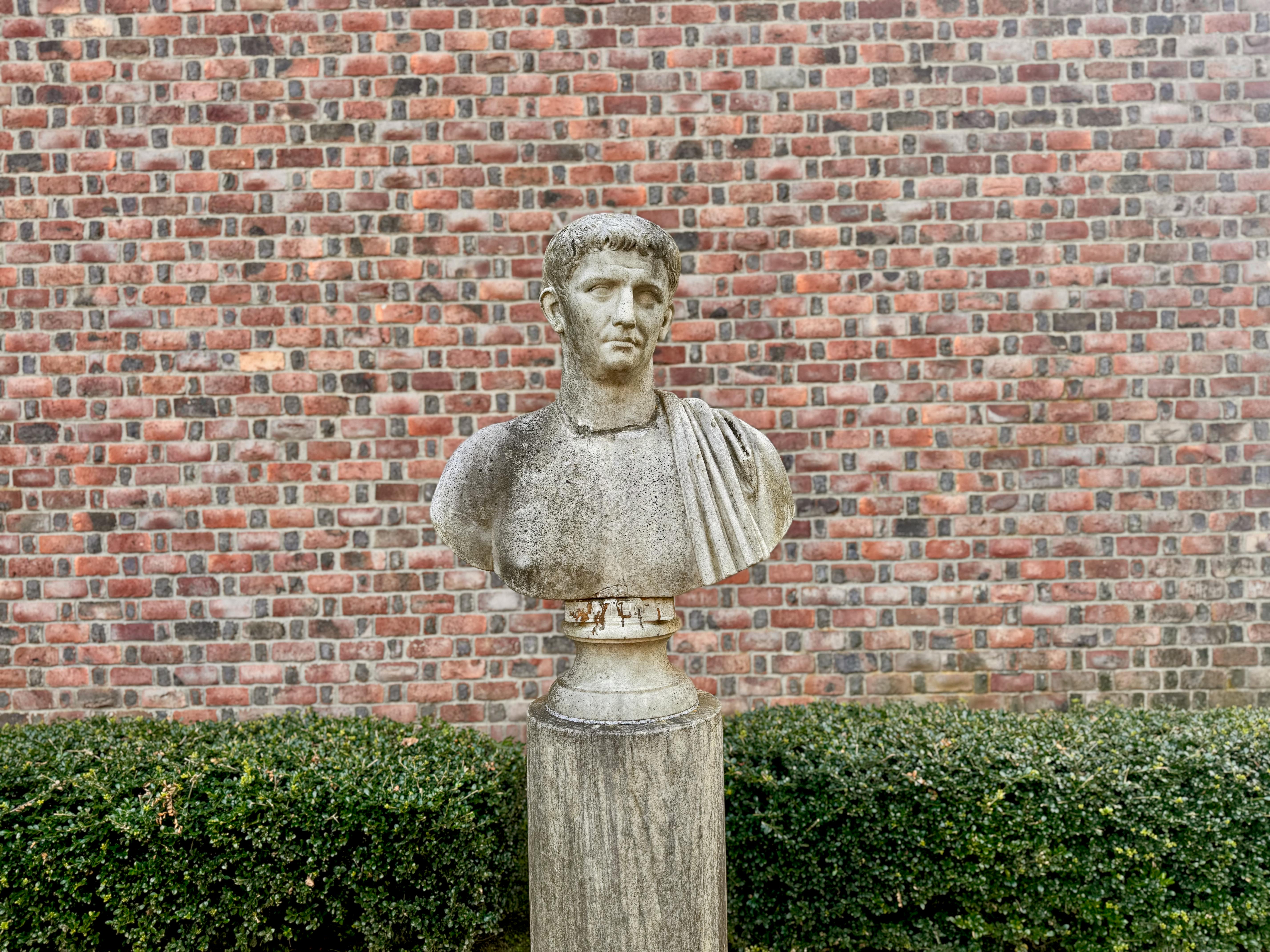 Ancient Roman Bust Against Brick Wall · Free Stock Photo
