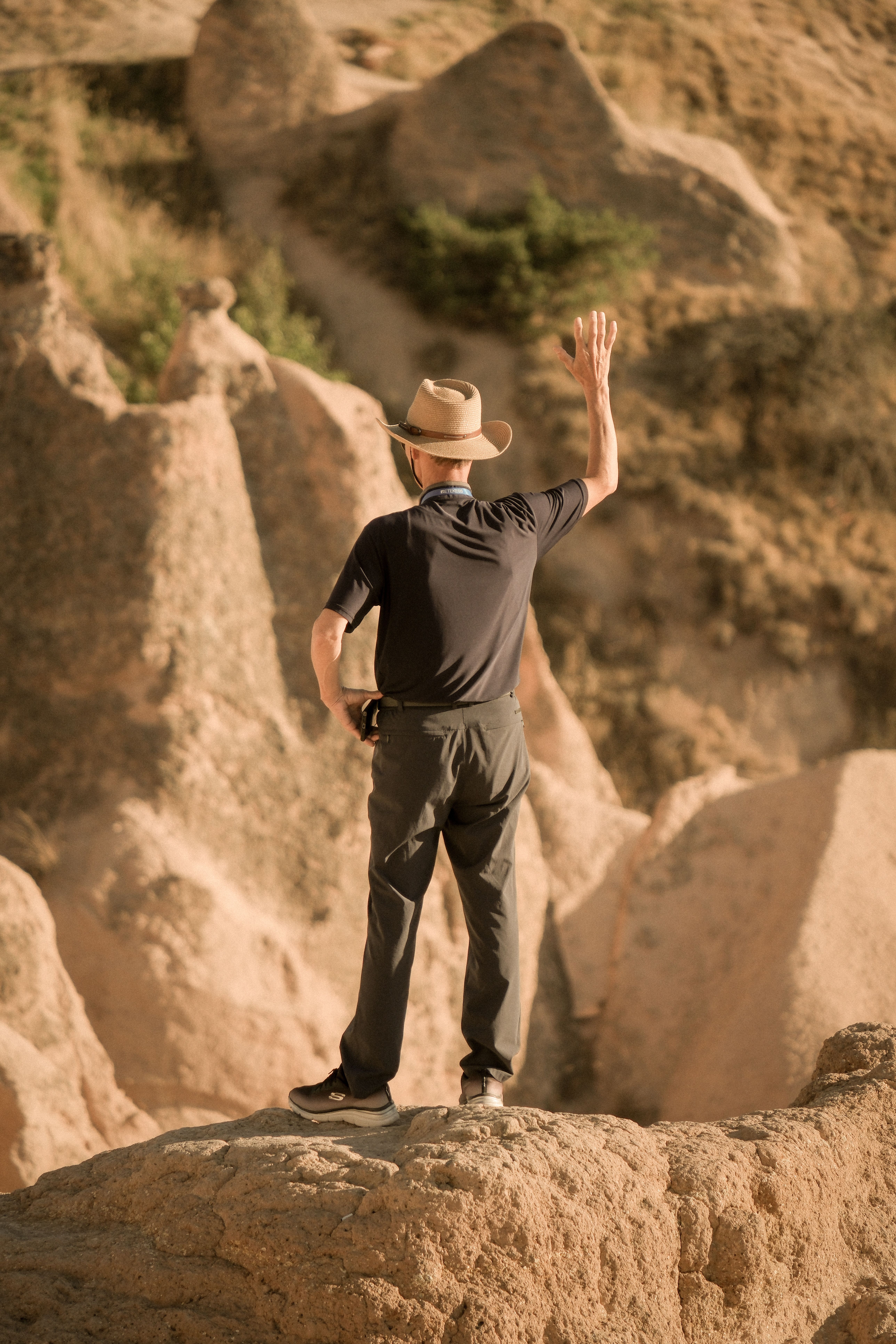 Man in Hat Exploring Rugged Rocky Terrain · Free Stock Photo