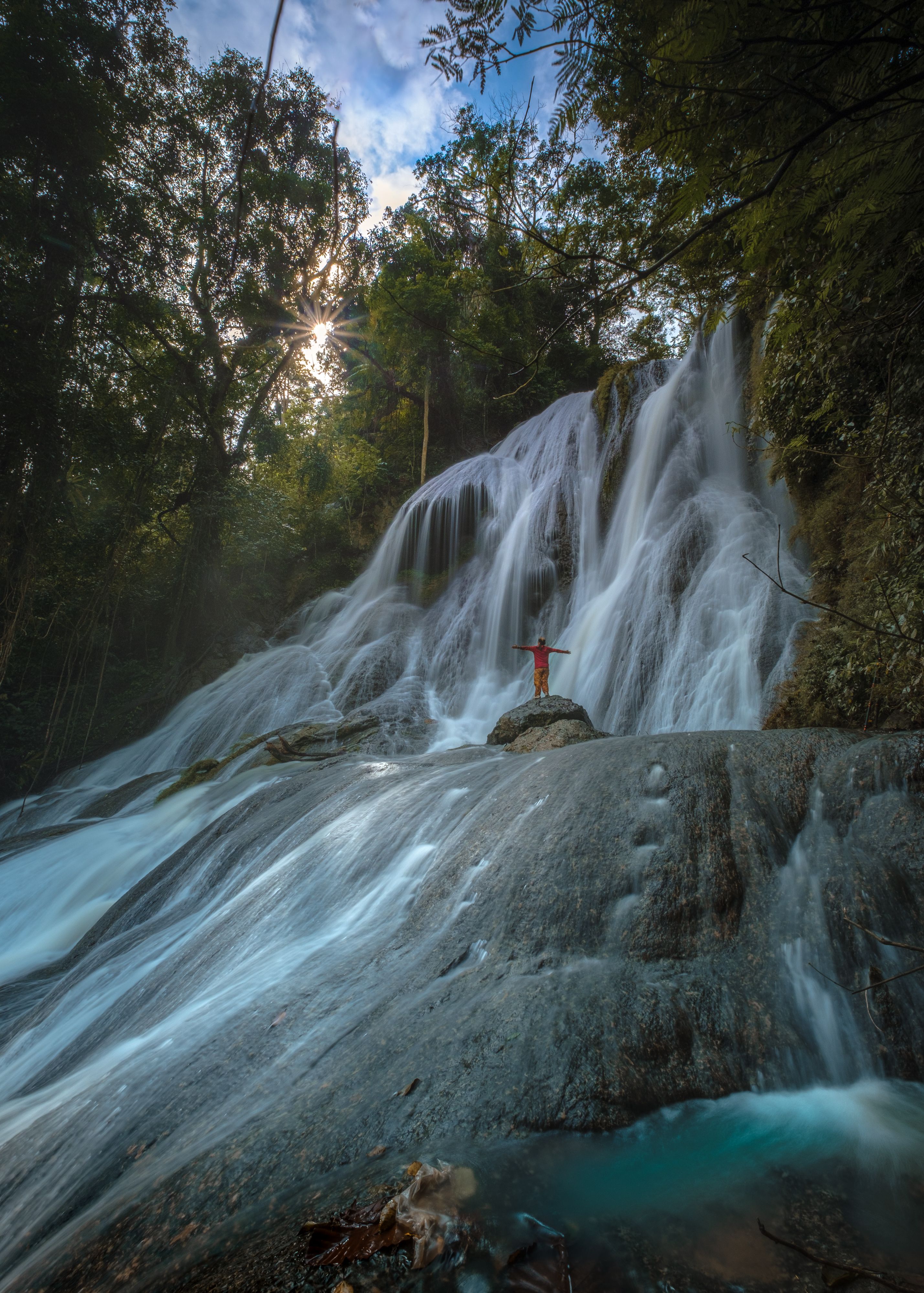 Low Angle Shot Of Woman Standing Under Waterfalls · Free Stock Photo