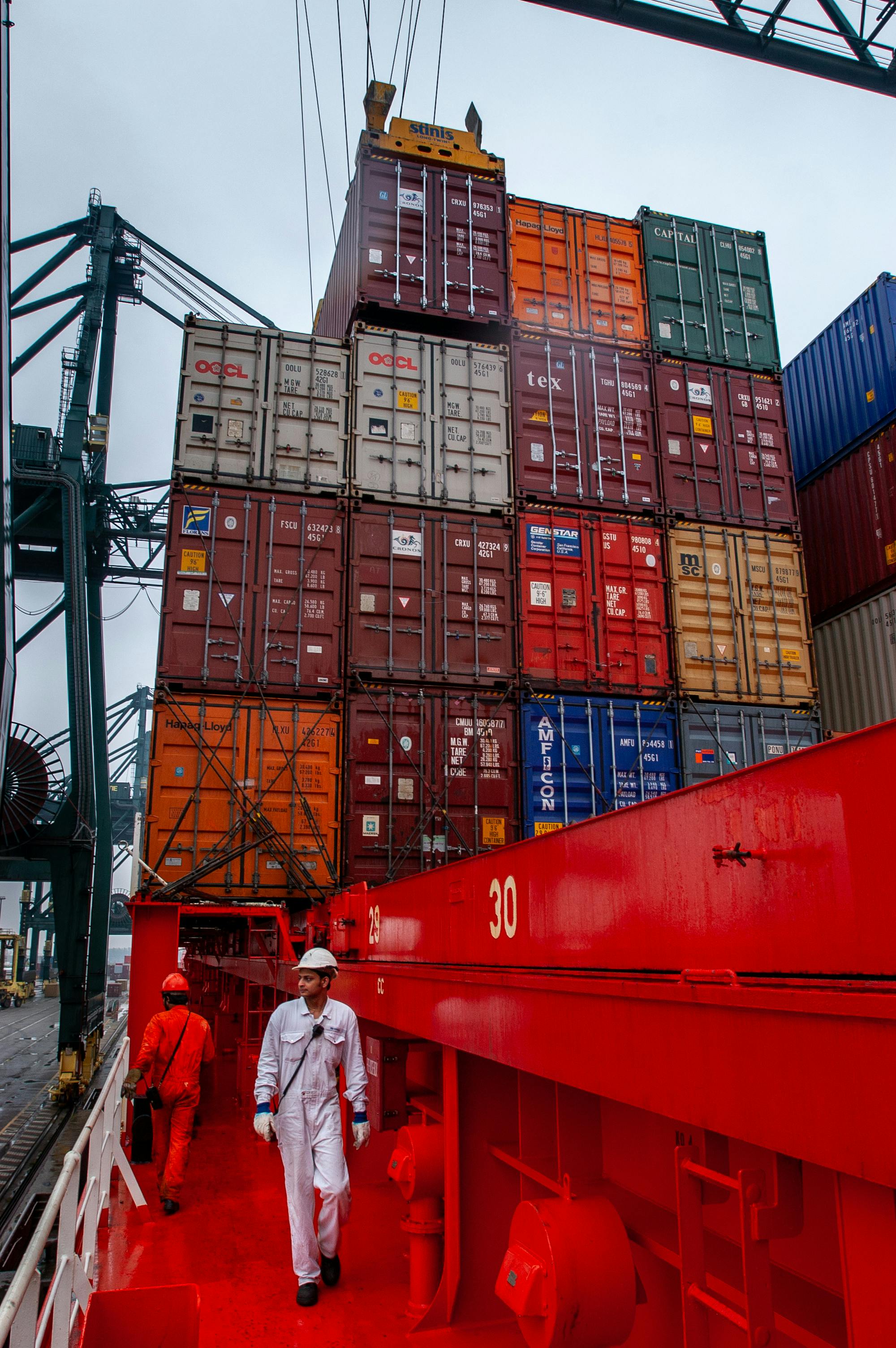 Crew on Container Ship Deck with Stacked Containers · Free Stock Photo
