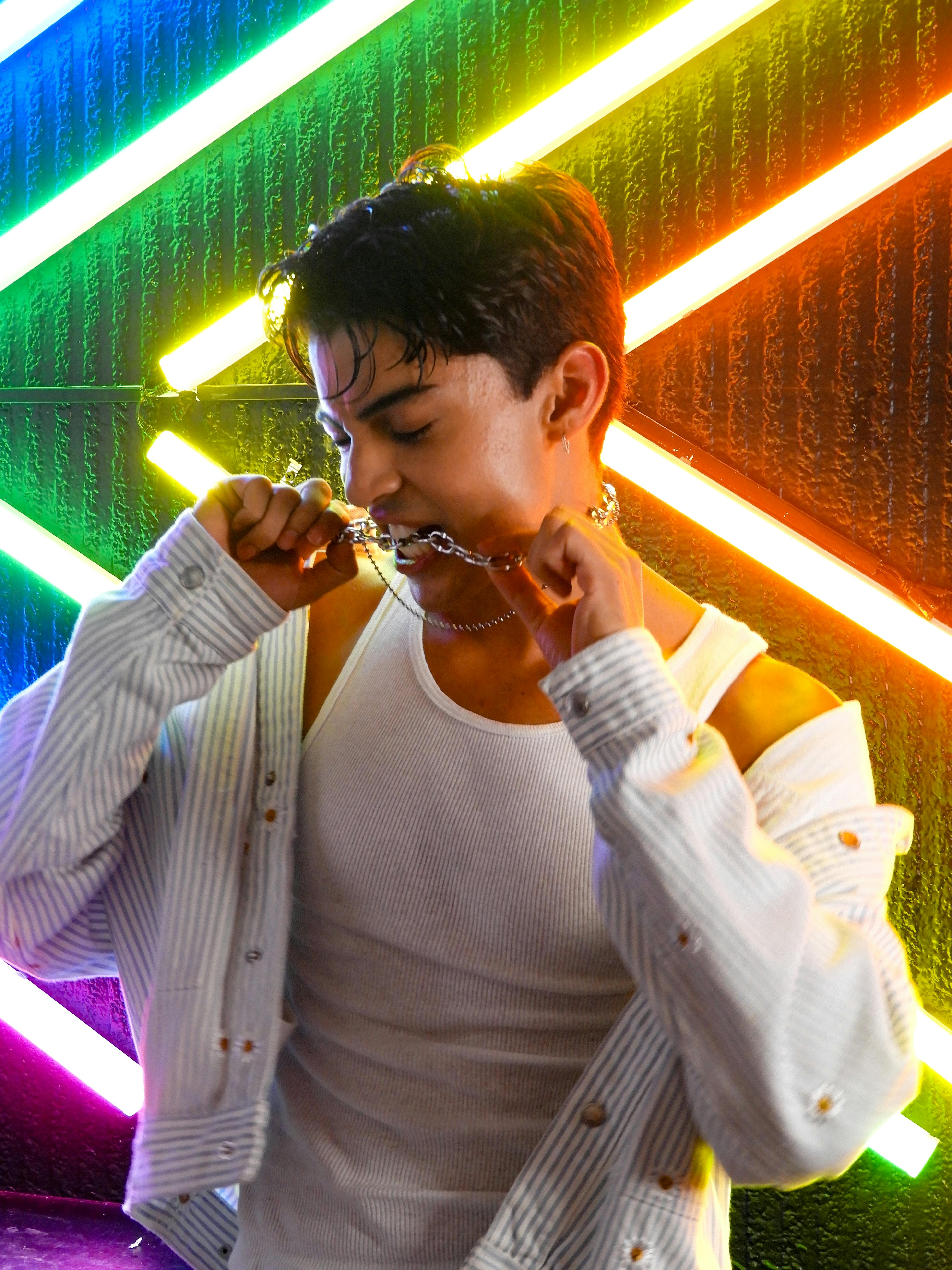 Stylish man against bright neon illumination · Free Stock Photo