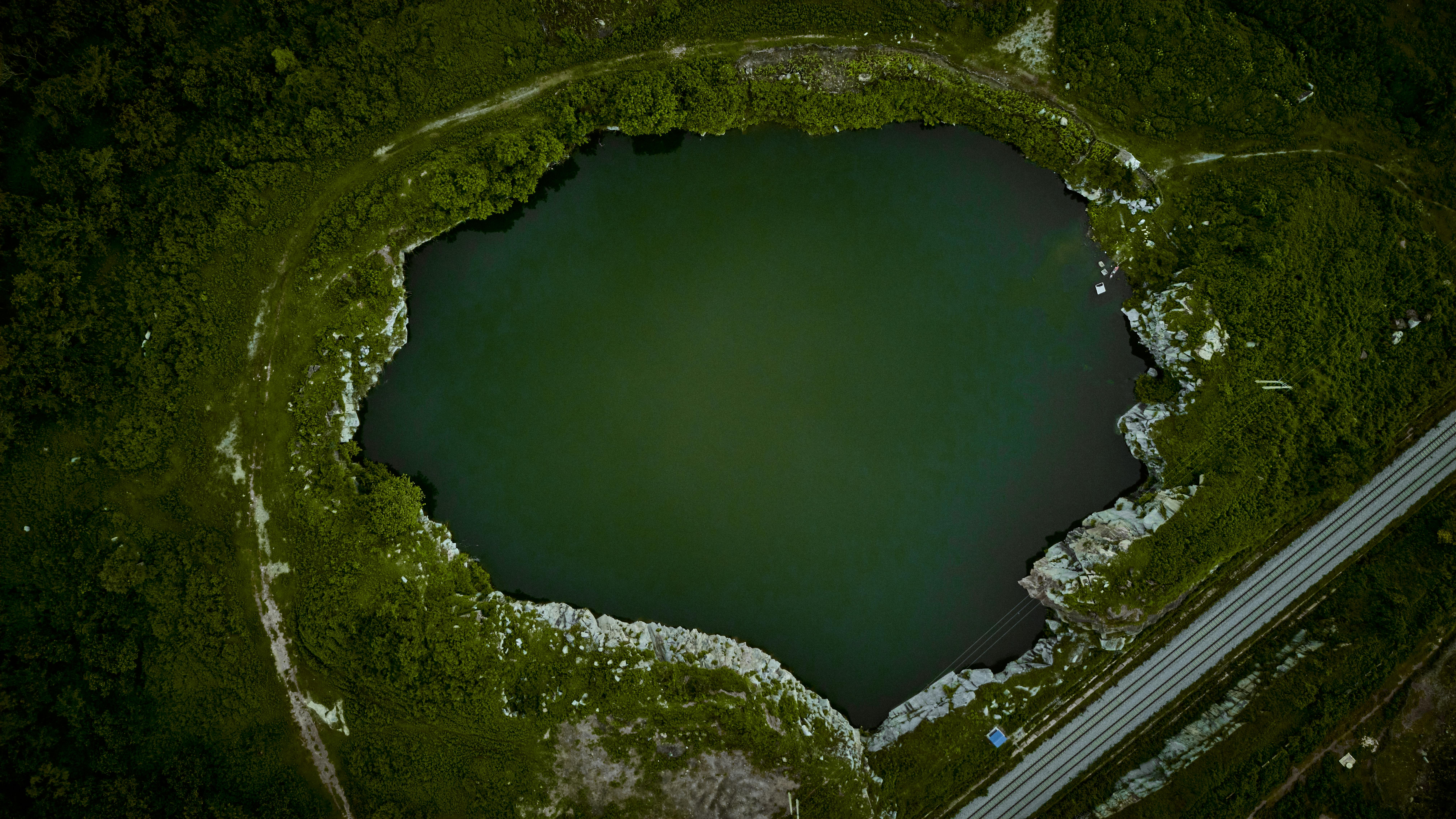 Aerial View of Lush Green Quarry Pond · Free Stock Photo