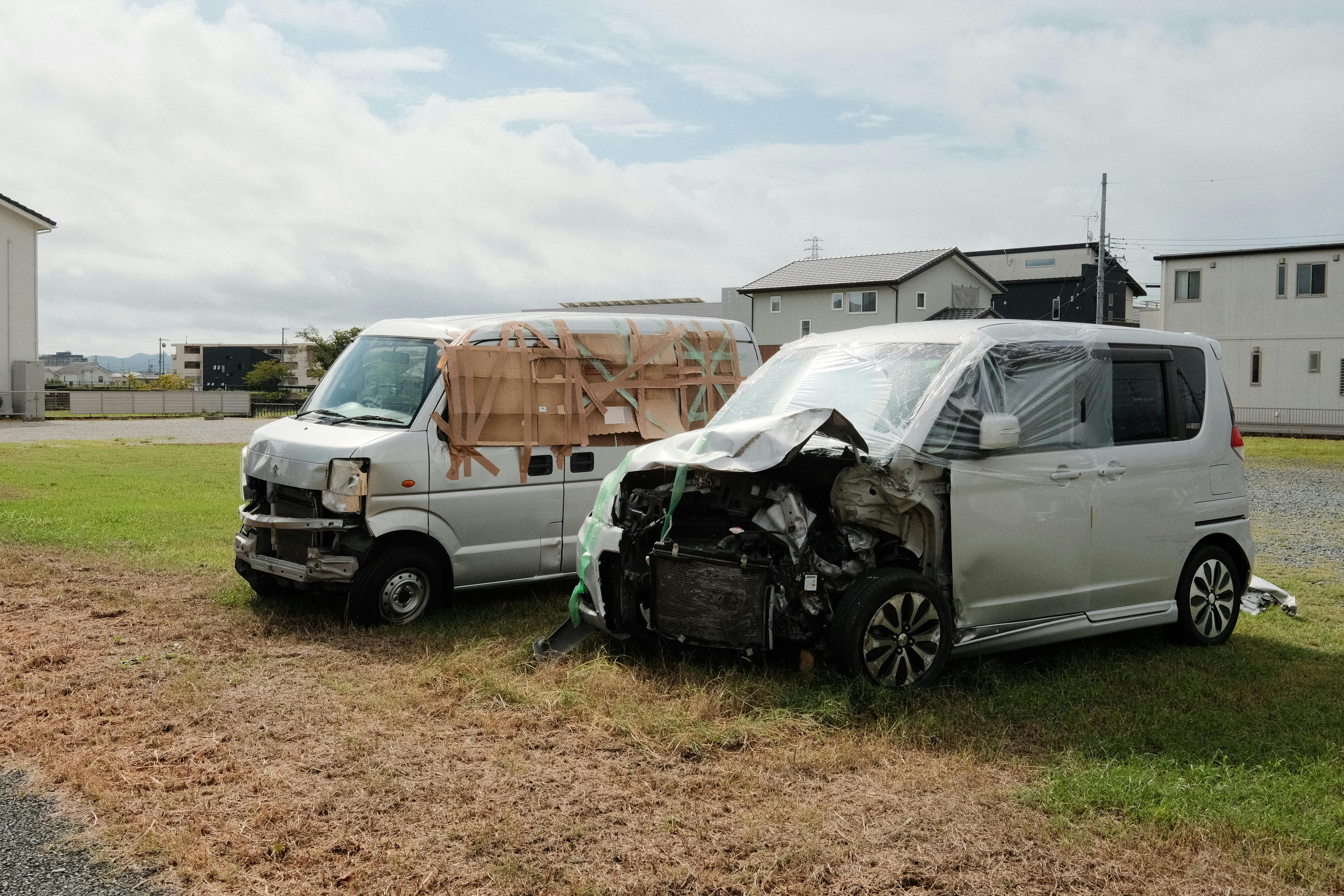 Two Damaged Vans in a Residential Area · Free Stock Photo