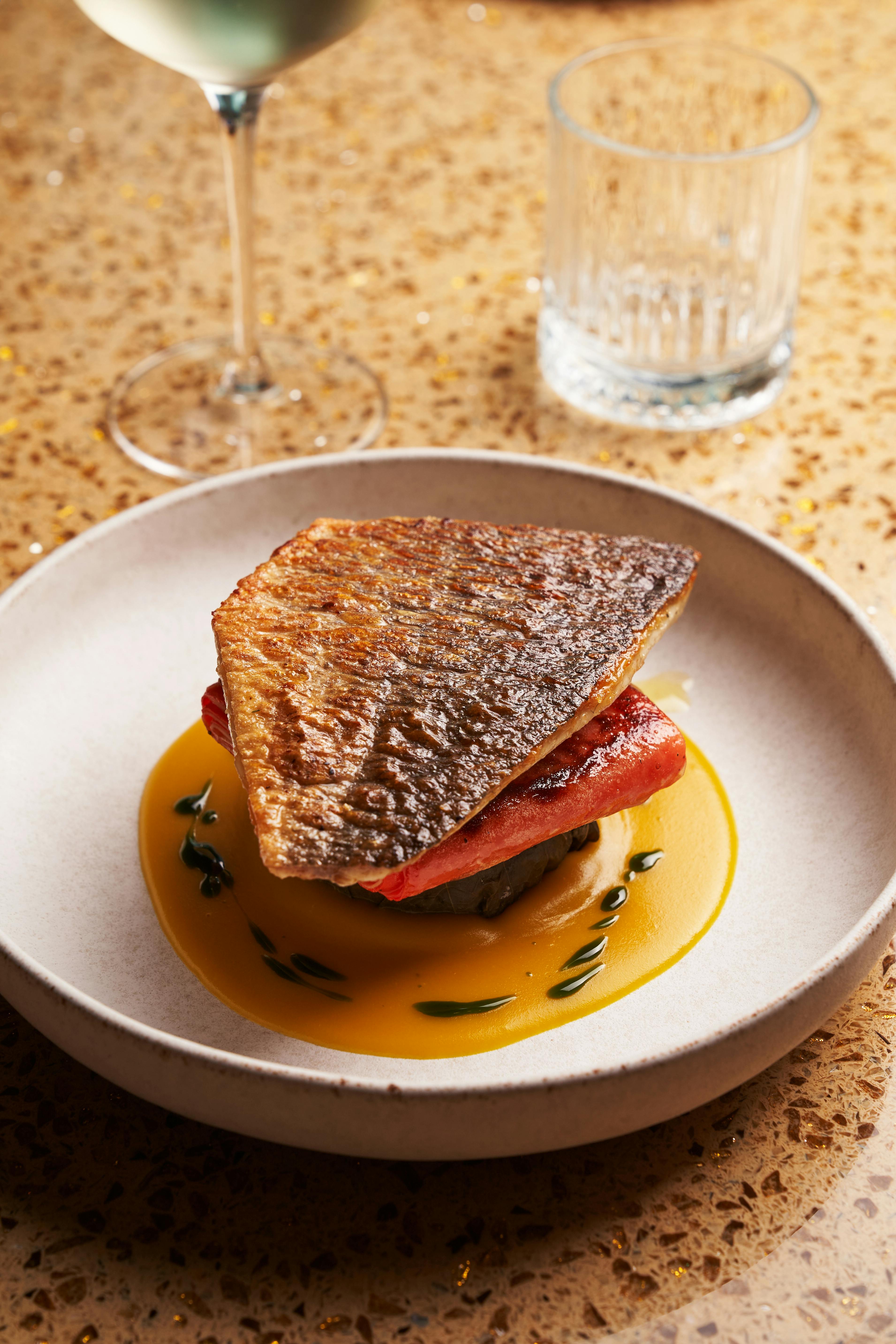 Gourmet Seared Fish Dish with Sauce and Wine · Free Stock Photo