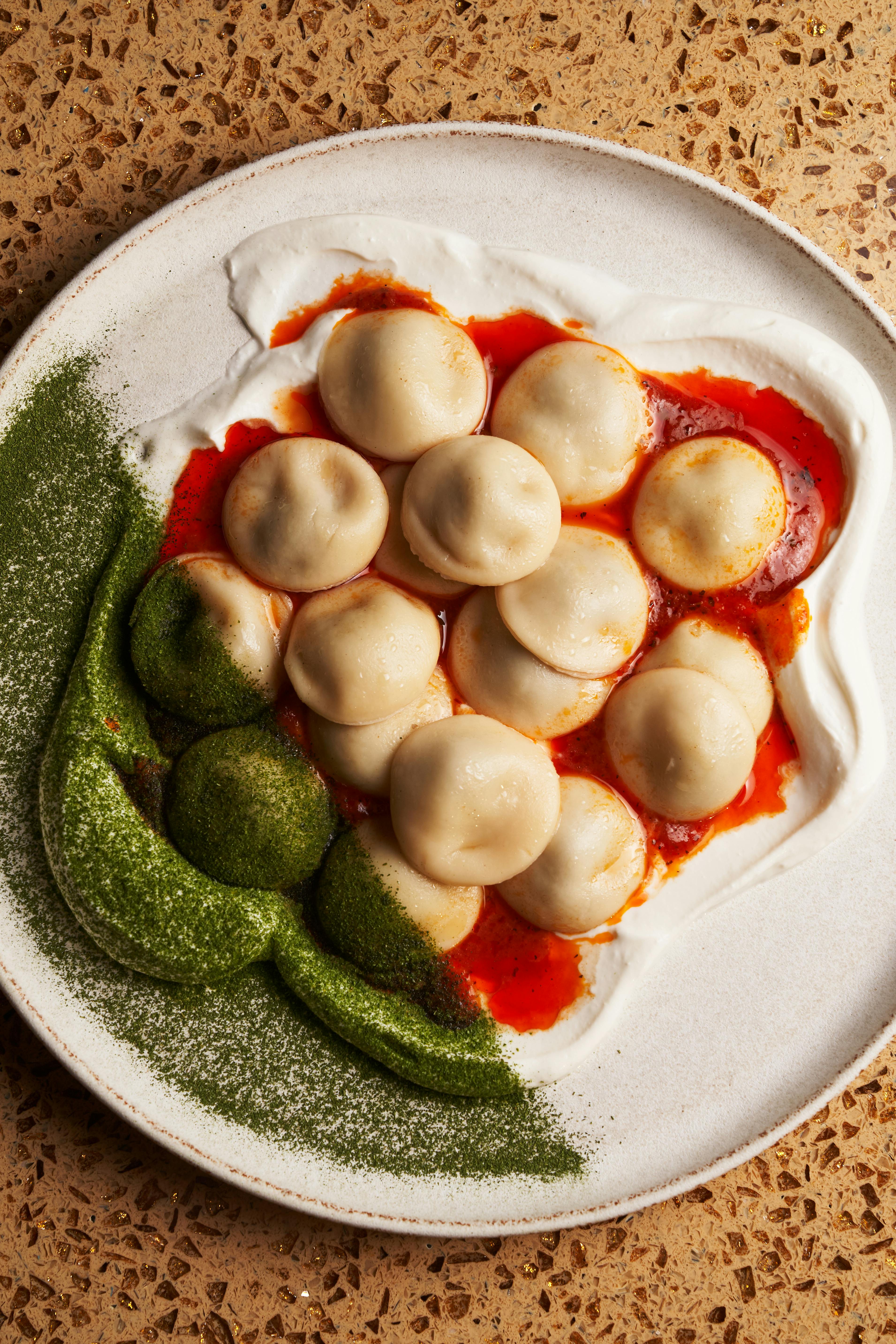 Vibrant Ravioli with Trio of Sauces on Plate · Free Stock Photo