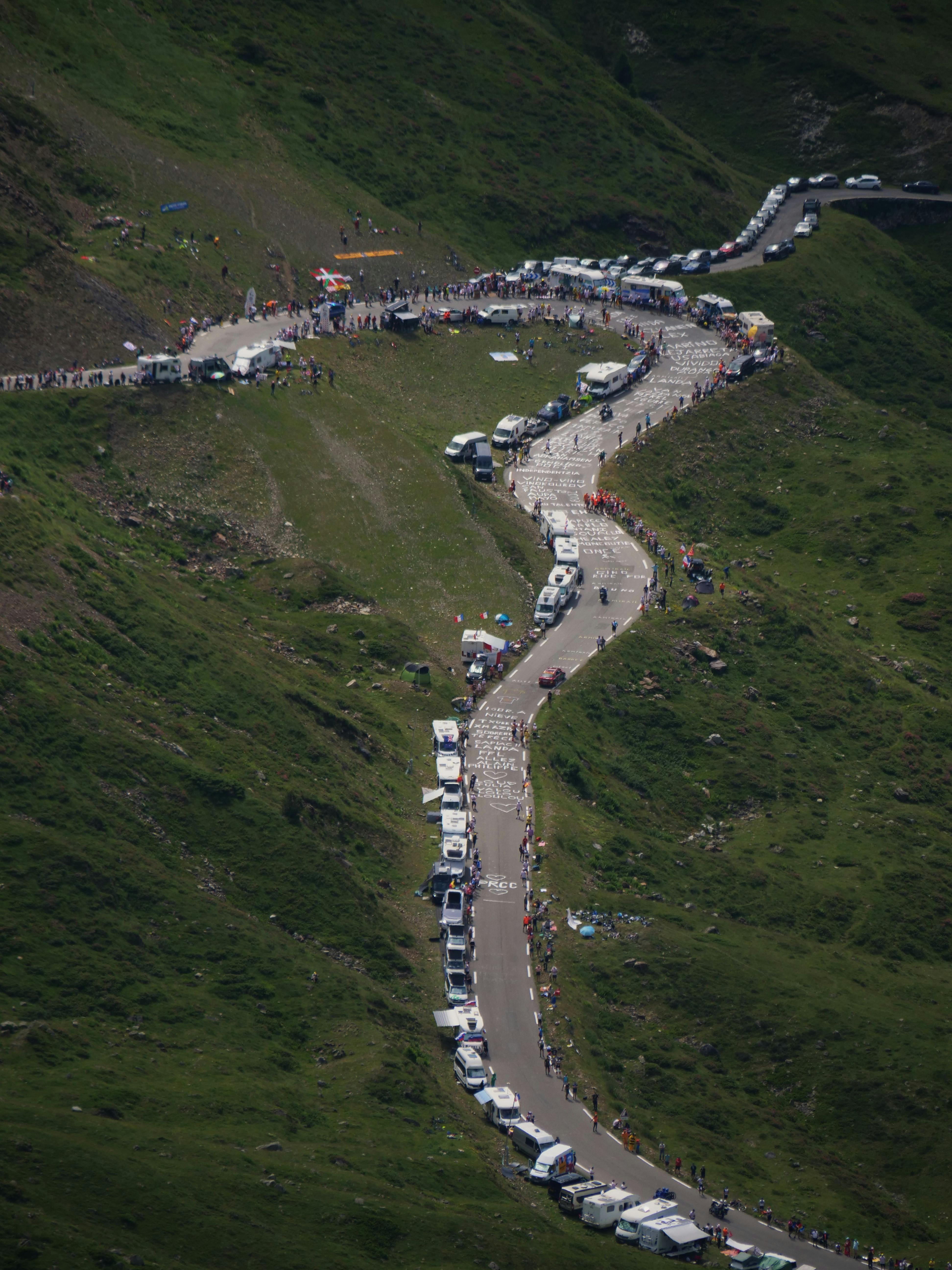 Scenic Mountain Road with Caravan Spectators · Free Stock Photo