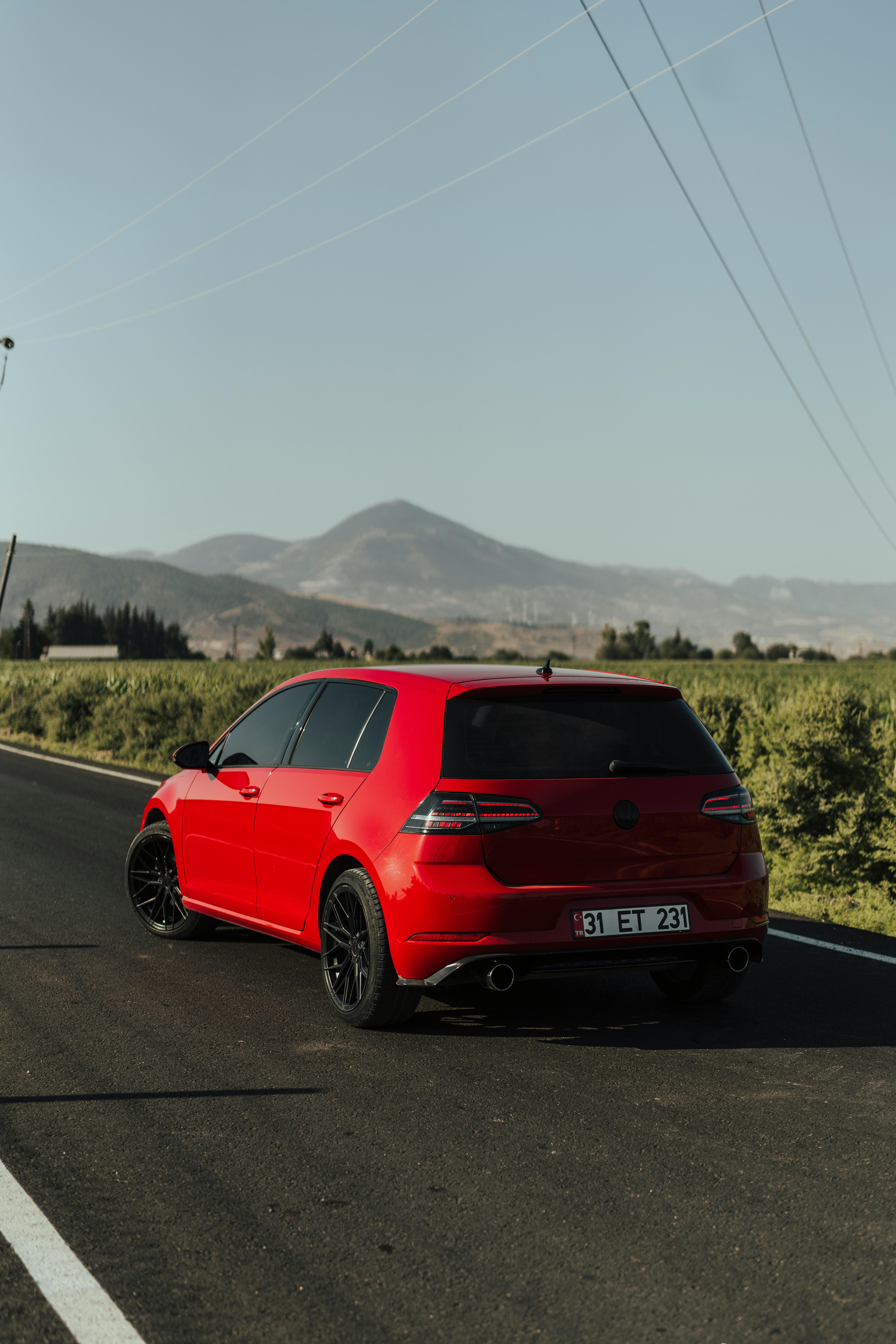 Red Volkswagen GTI on Scenic Road · Free Stock Photo