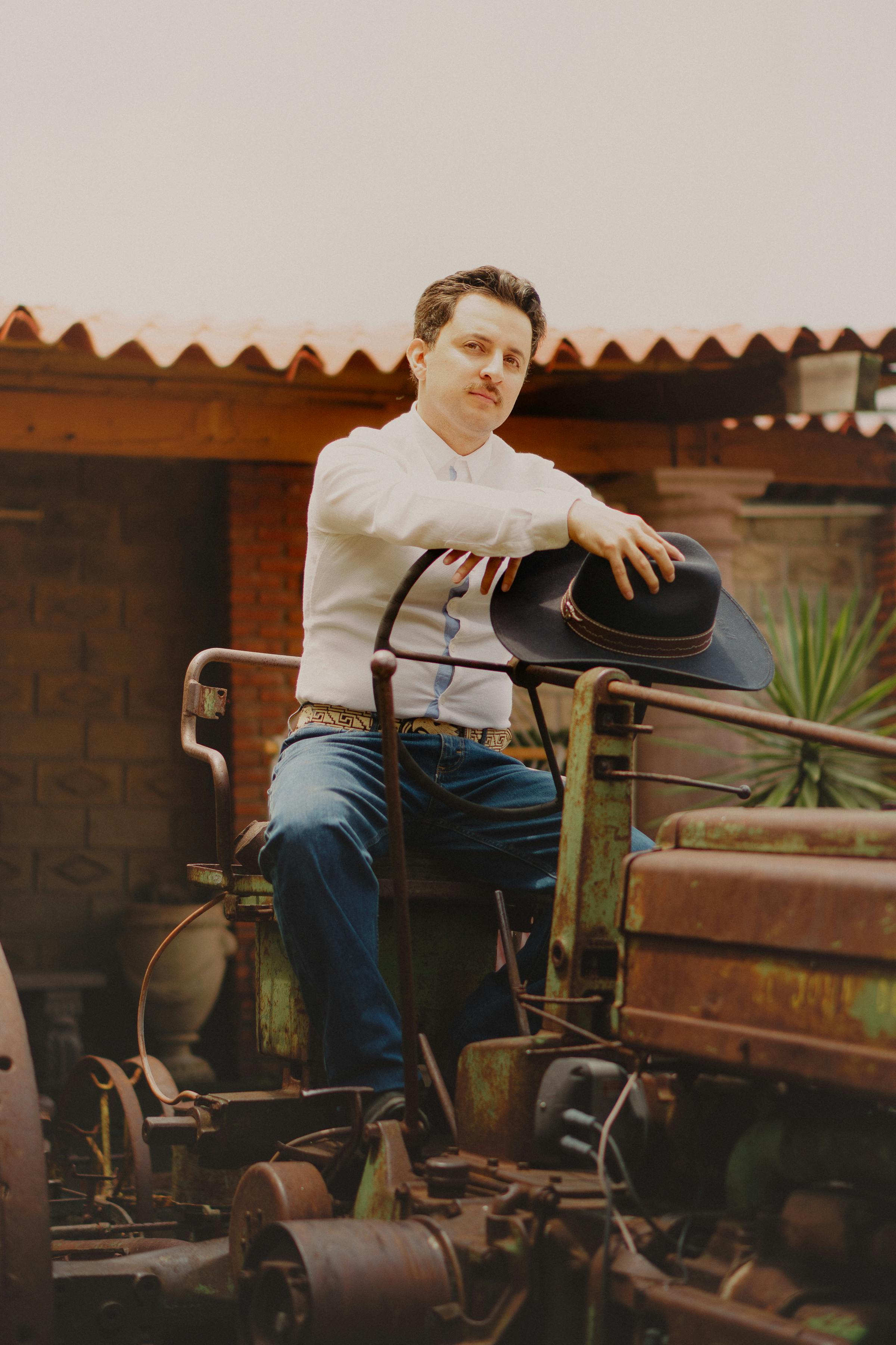 Man on Vintage Tractor in Mexican Farm Setting · Free Stock Photo