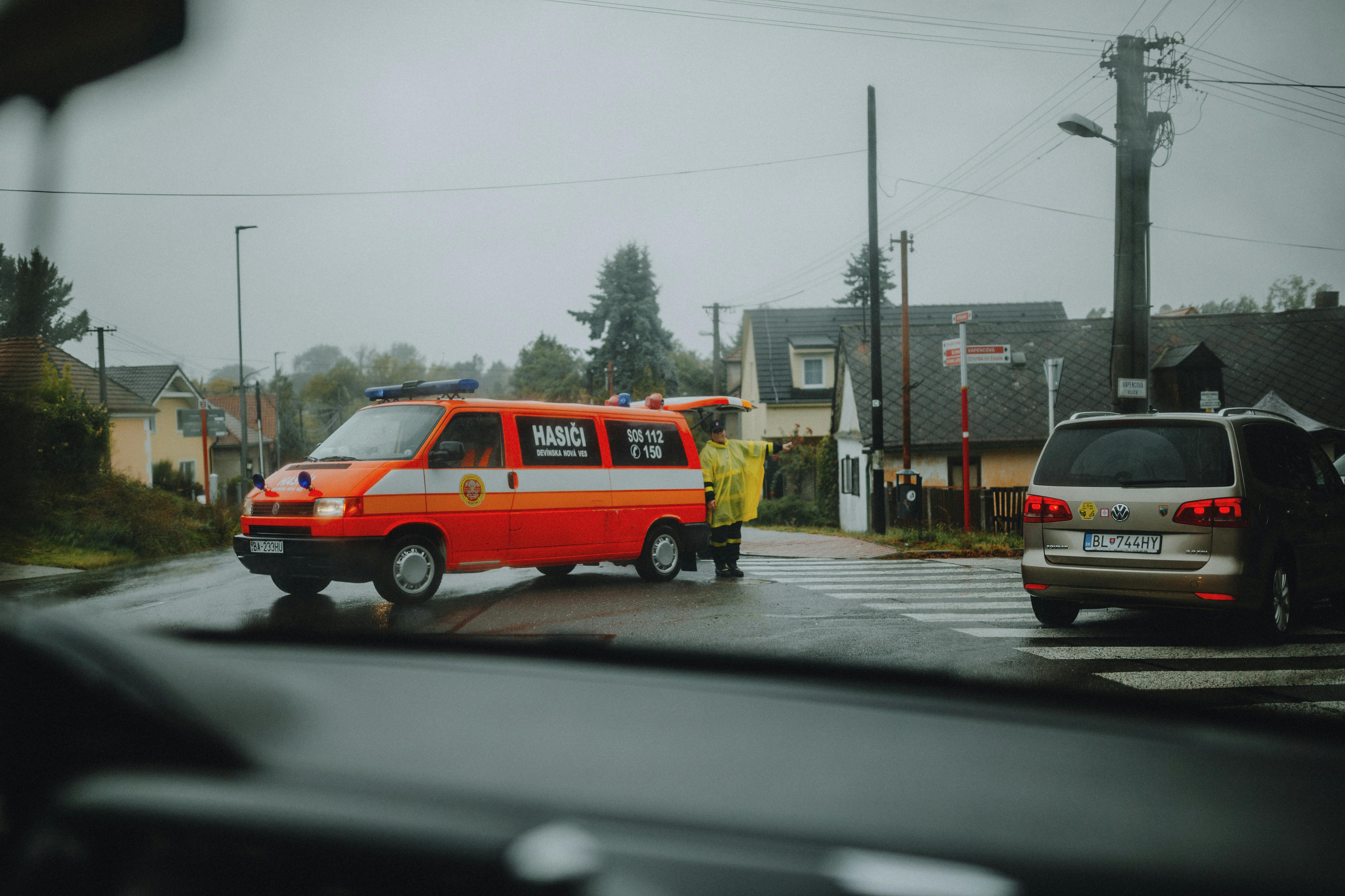 Emergency Vehicle Blocking Street on Rainy Day · Free Stock Photo