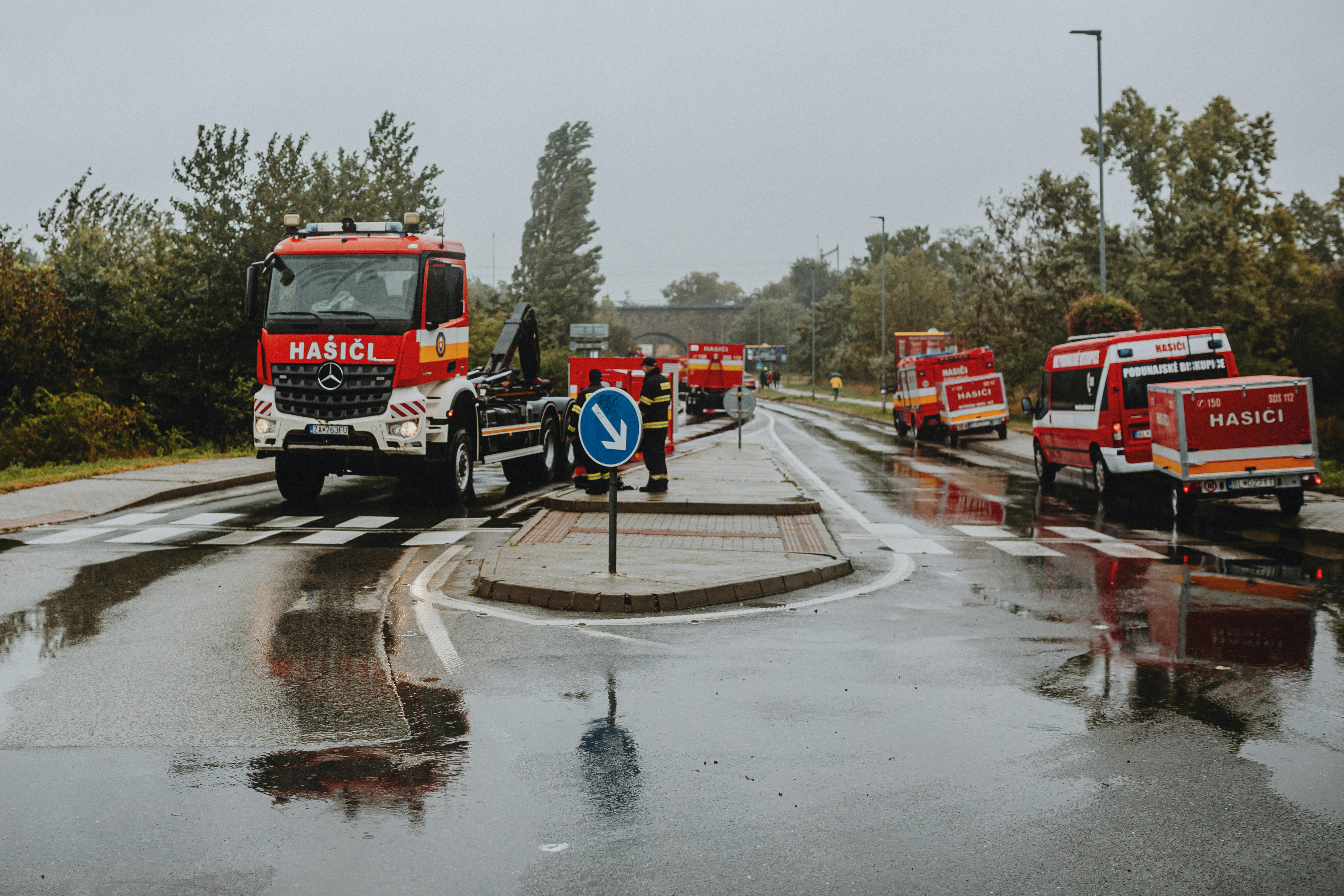Firefighting Vehicles on Wet Road in Rainy Weather · Free Stock Photo