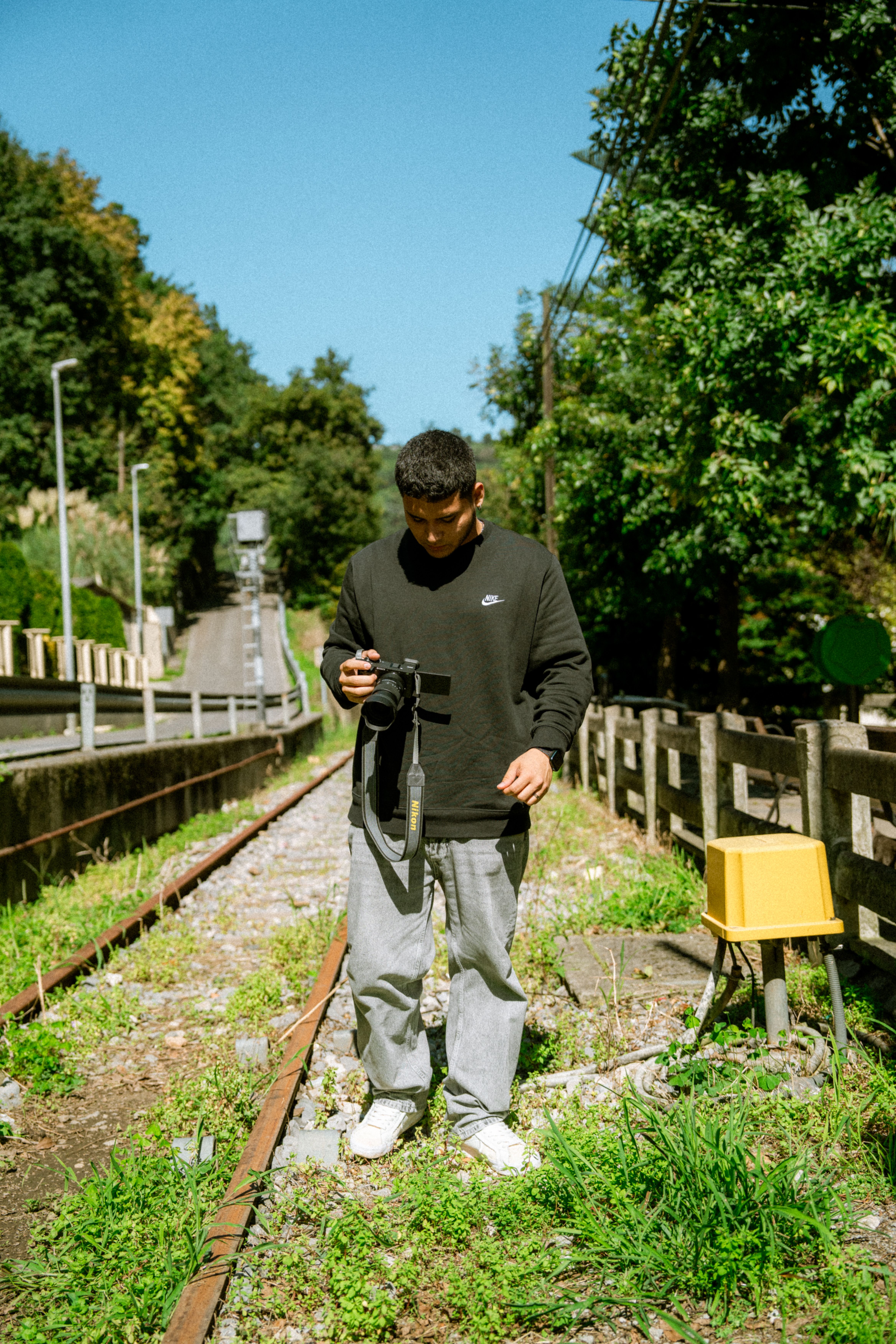 Young Man Exploring Outdoor Railway Track · Free Stock Photo