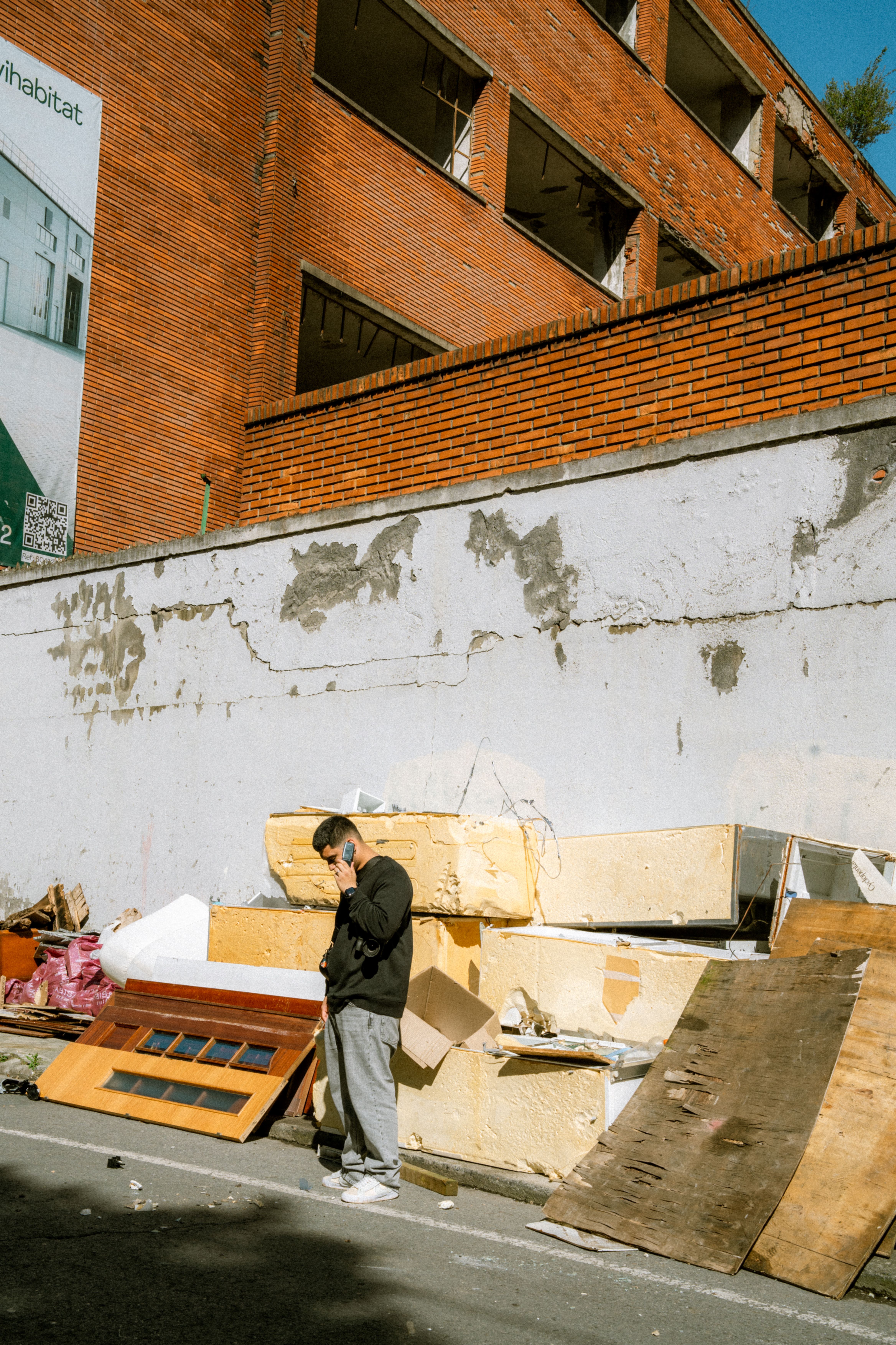 Urban Scene with Person Amidst Discarded Materials · Free Stock Photo