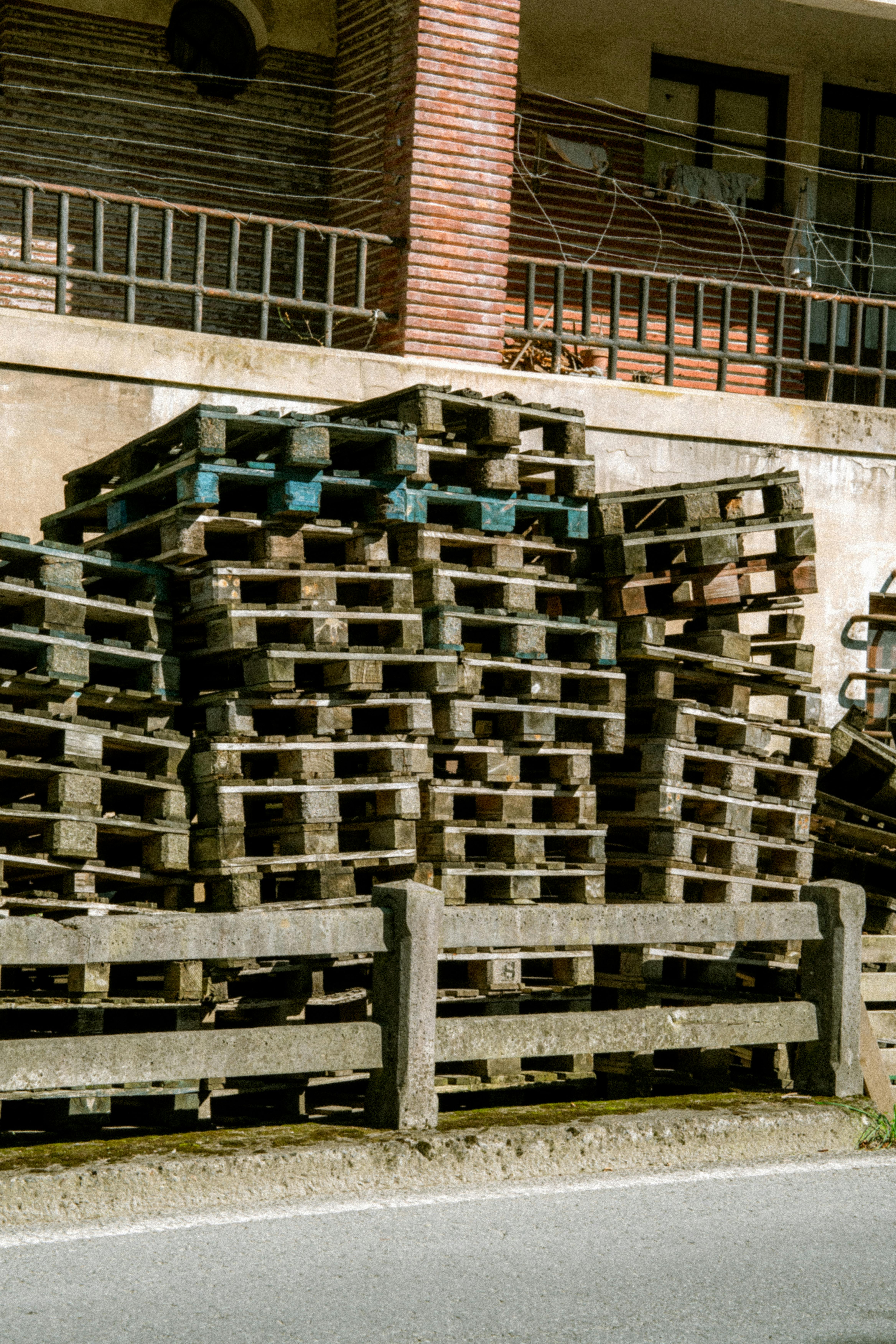 Stack of Wooden Pallets Outdoors in Urban Area · Free Stock Photo