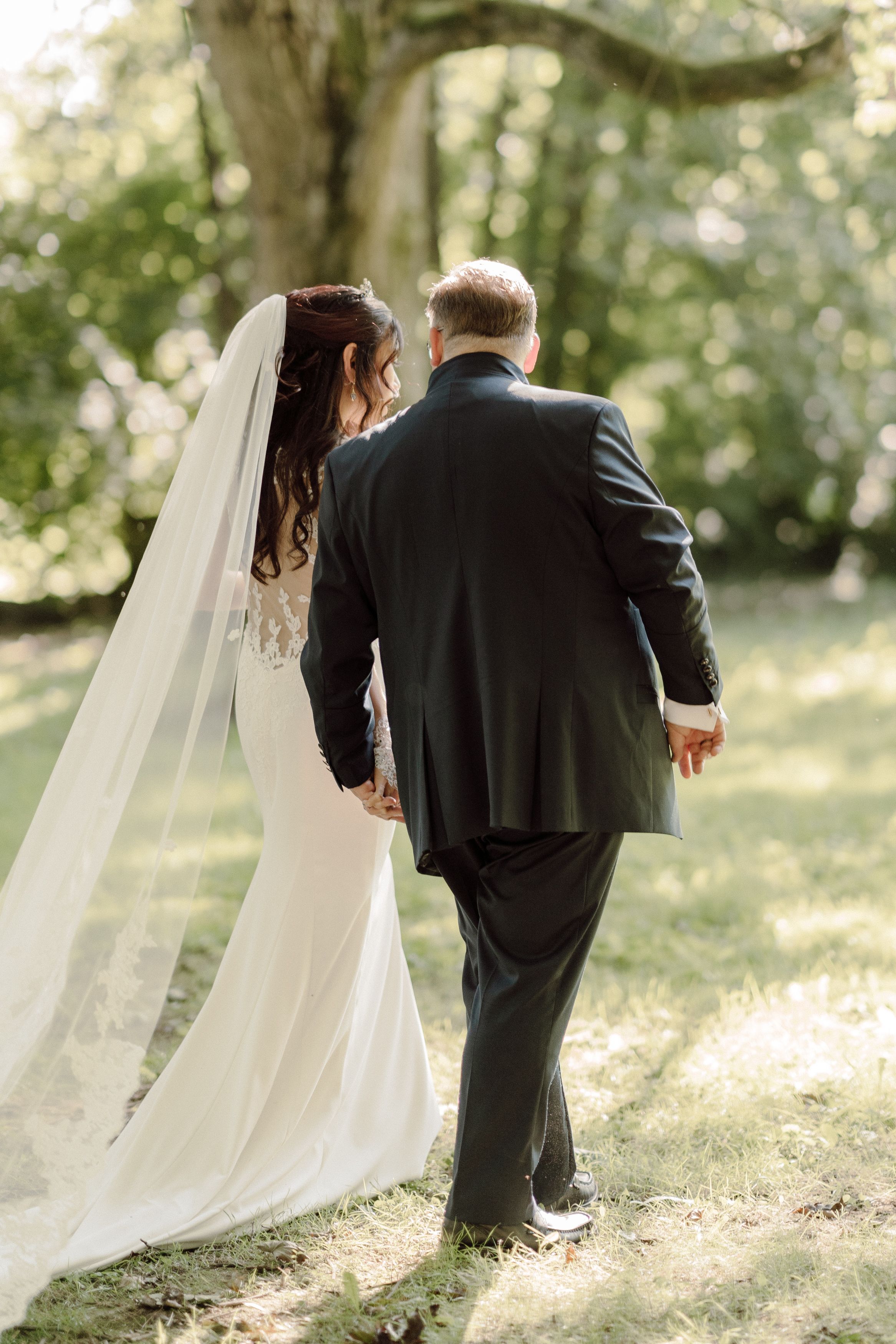 Elegant Outdoor Wedding Couple Walking Together · Free Stock Photo
