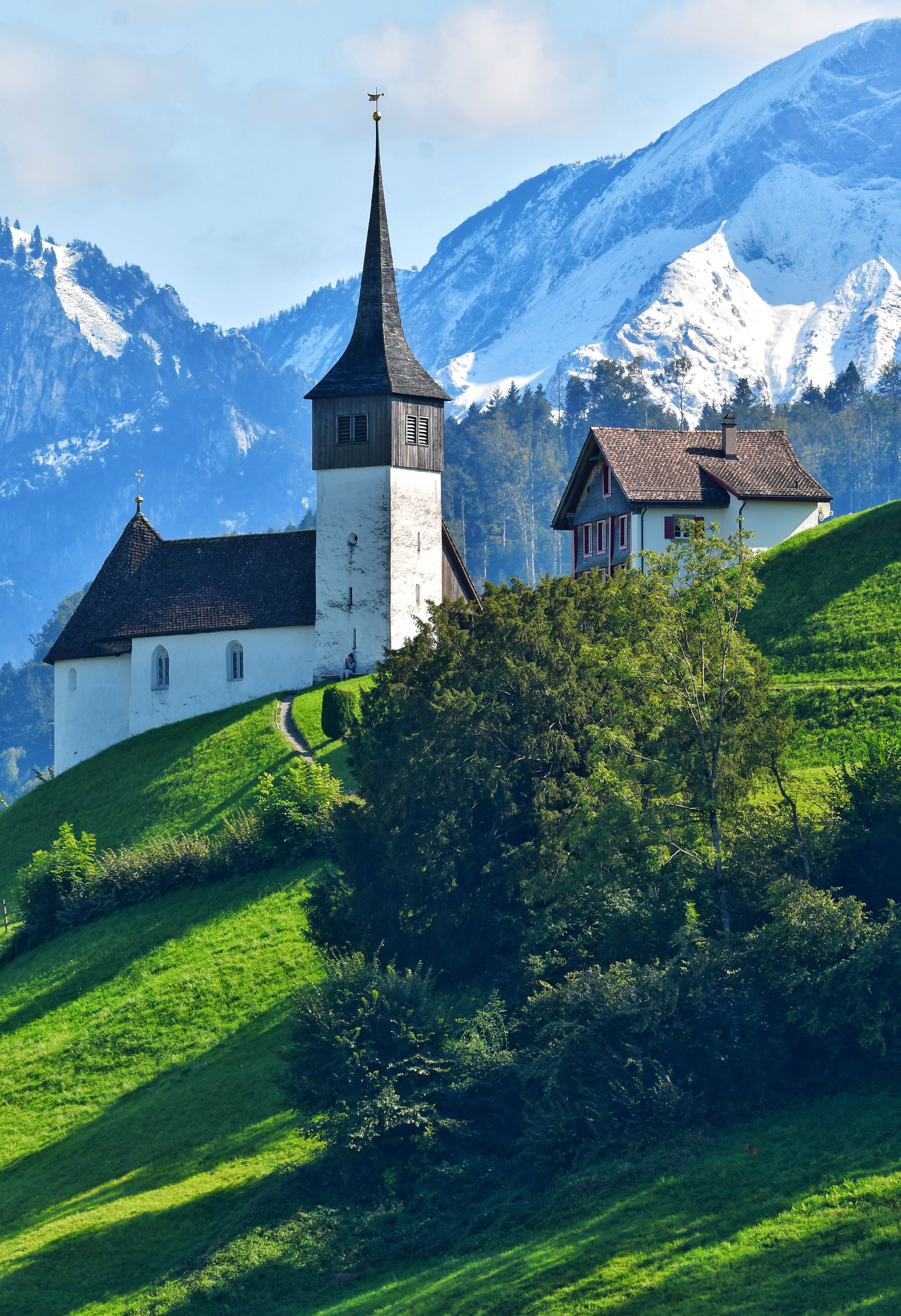 Scenic Alpine Church with Snowy Mountain Background · Free Stock Photo