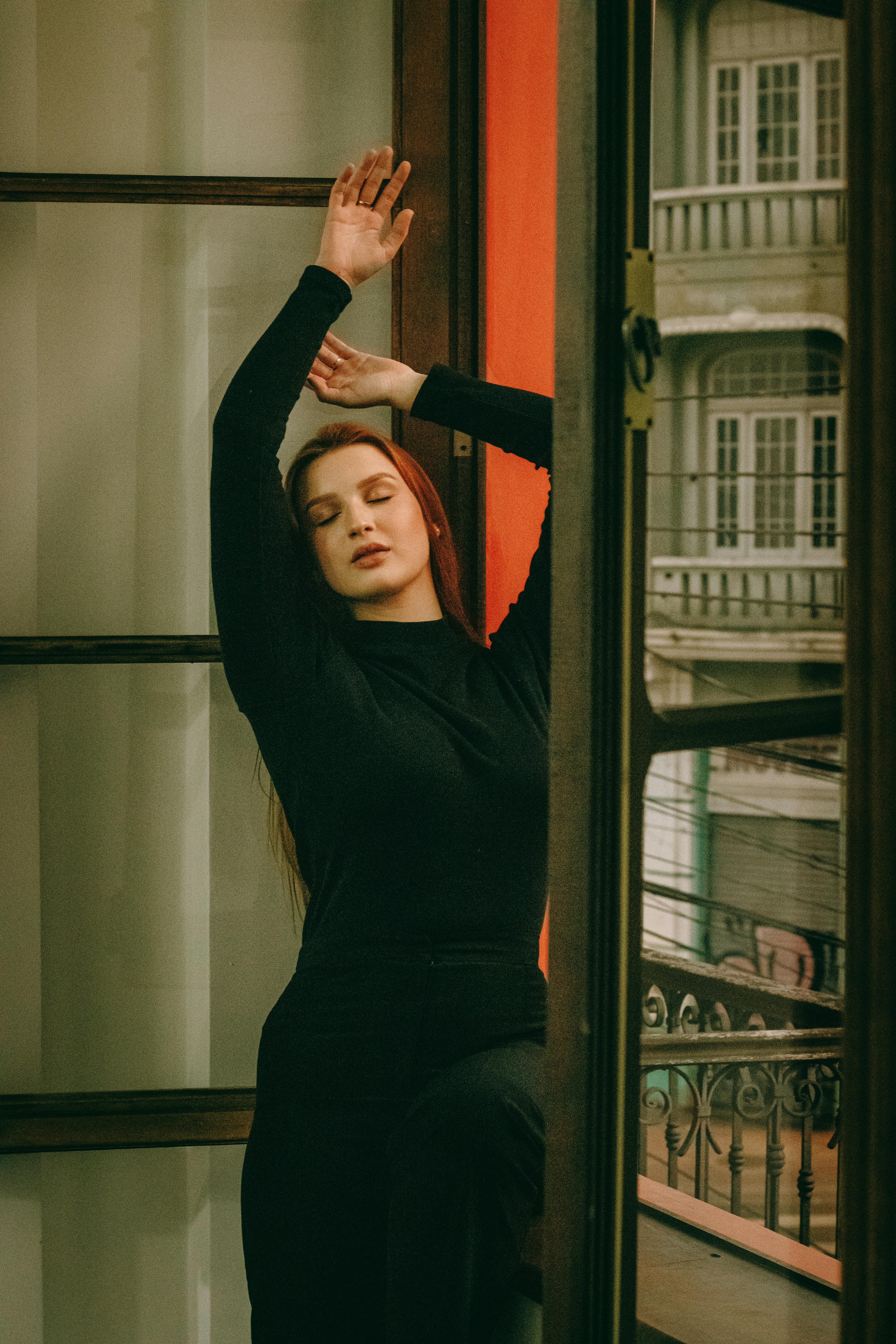 Elegance in Urban Window Frame Portrait · Free Stock Photo