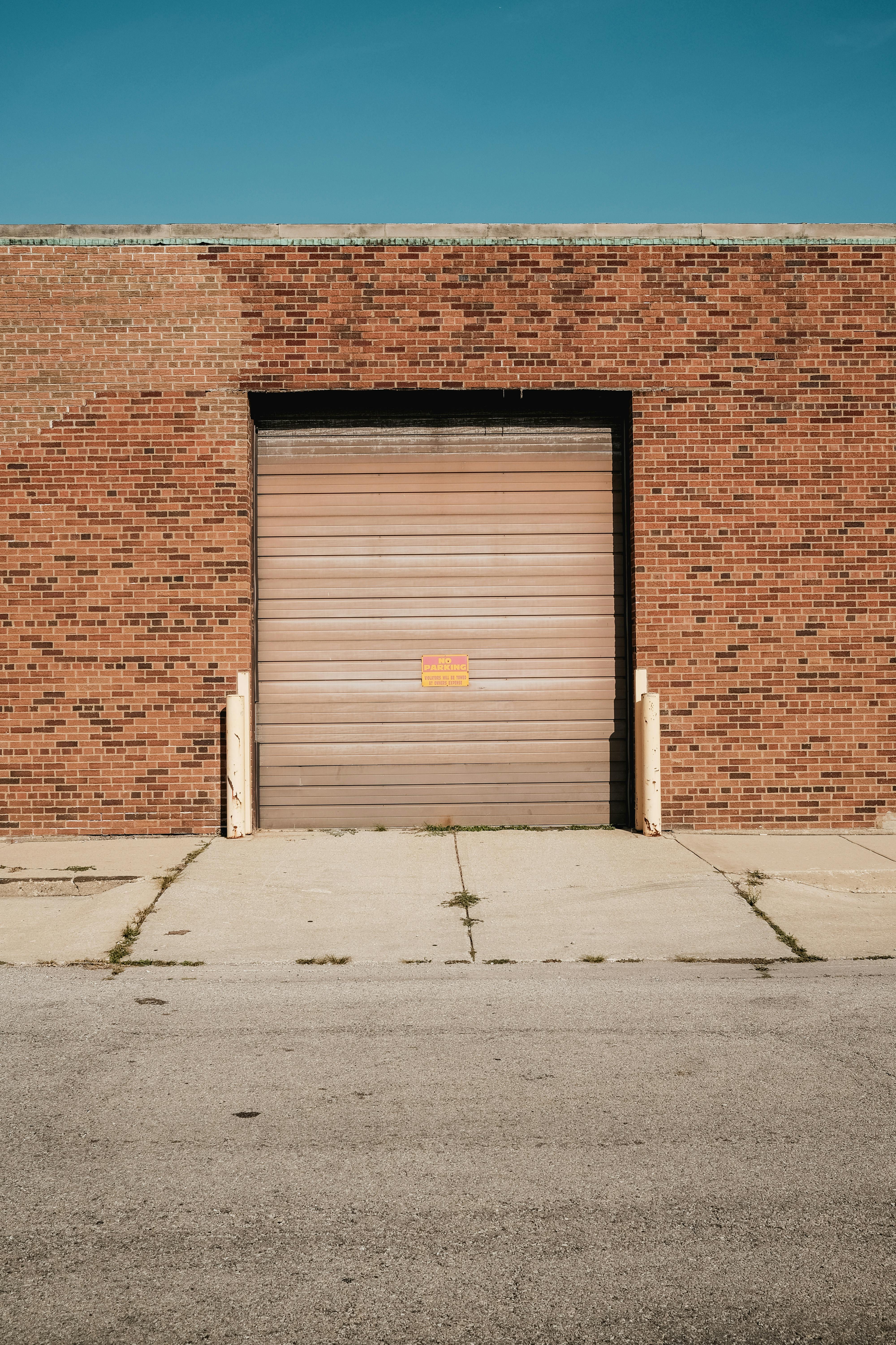 Brick Warehouse Exterior with Roller Door · Free Stock Photo