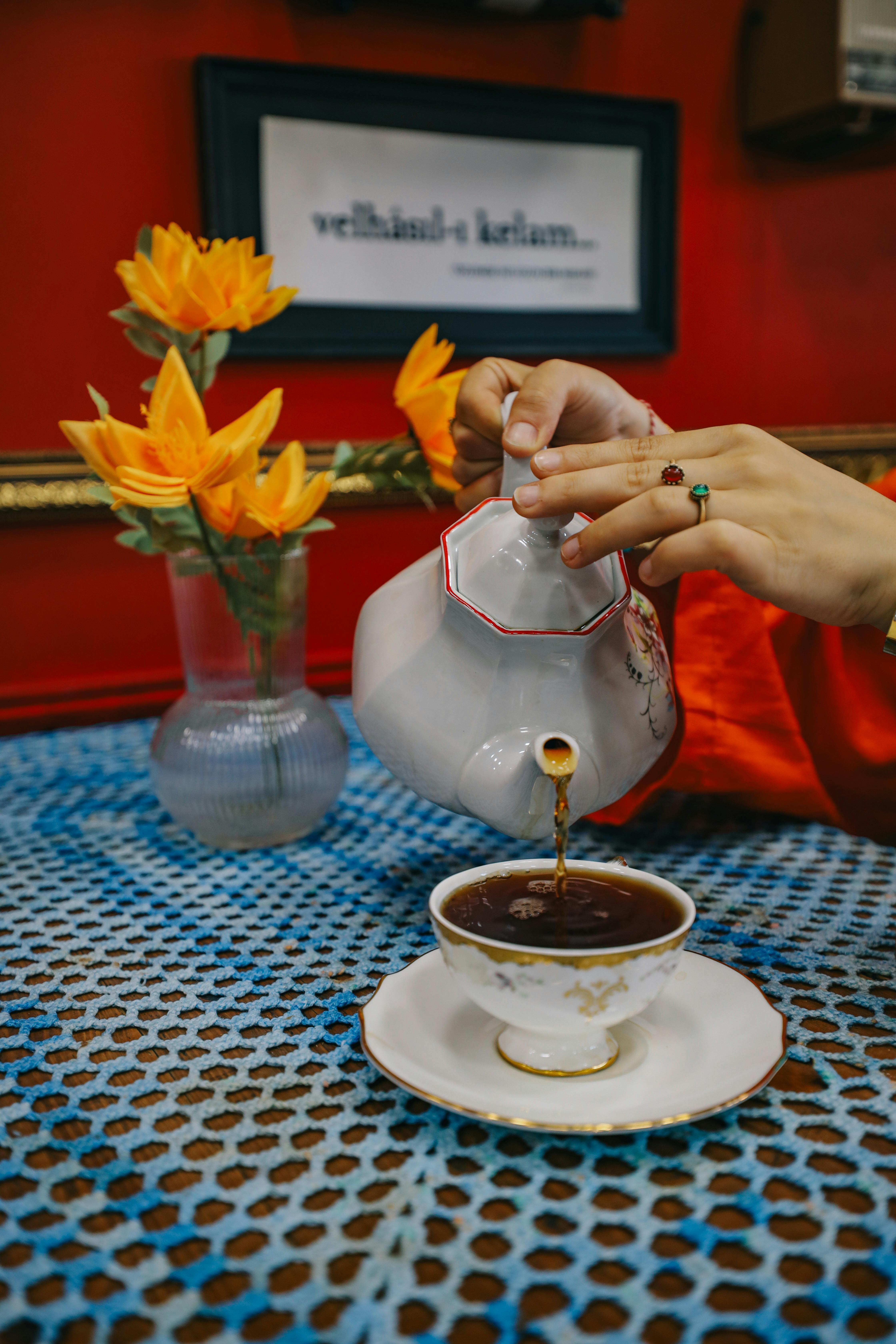 Pouring Turkish Tea in a Vibrant Cafe Setting · Free Stock Photo